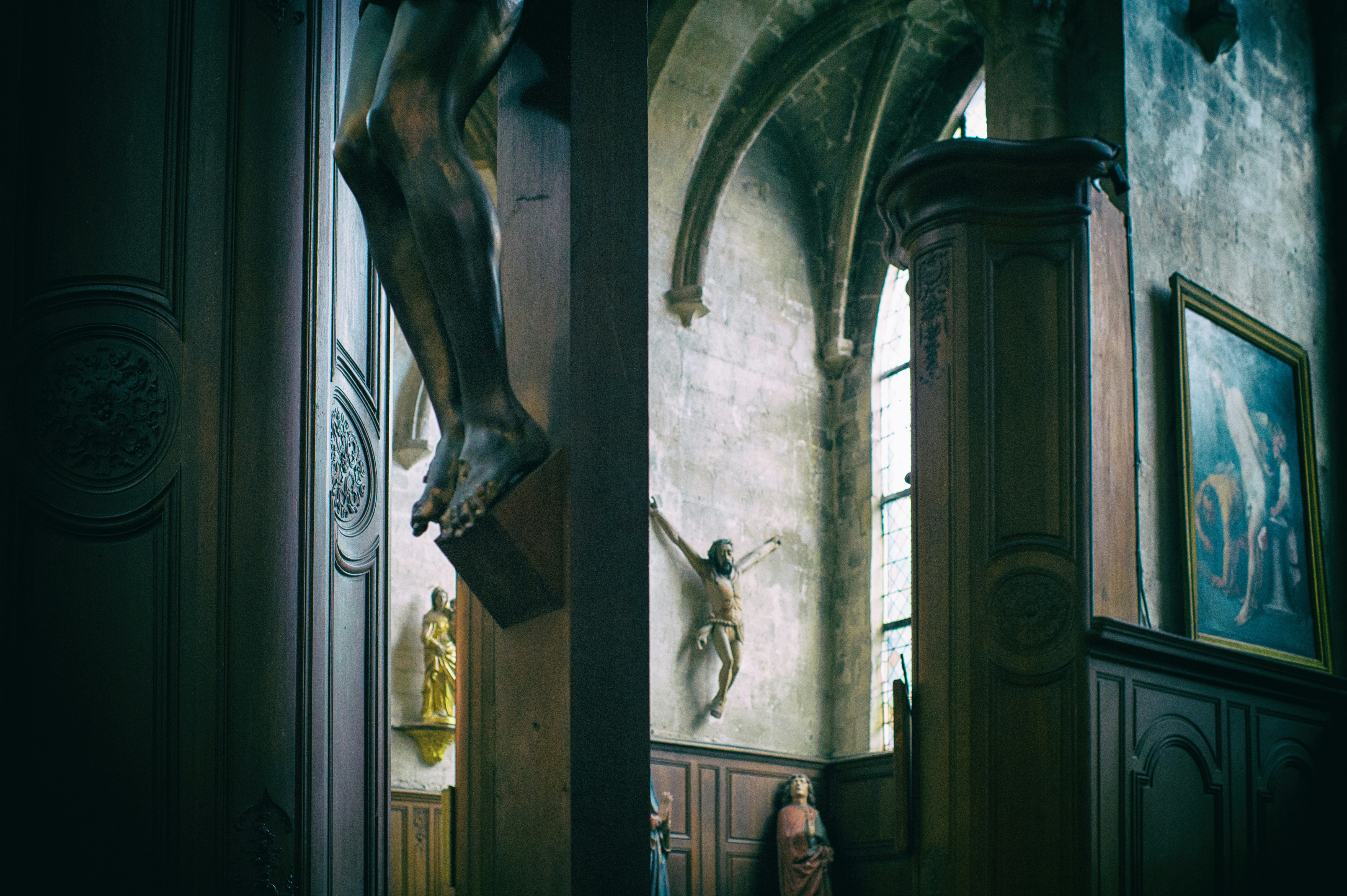 A statue of a person hanging from the ceiling of a building photo ...