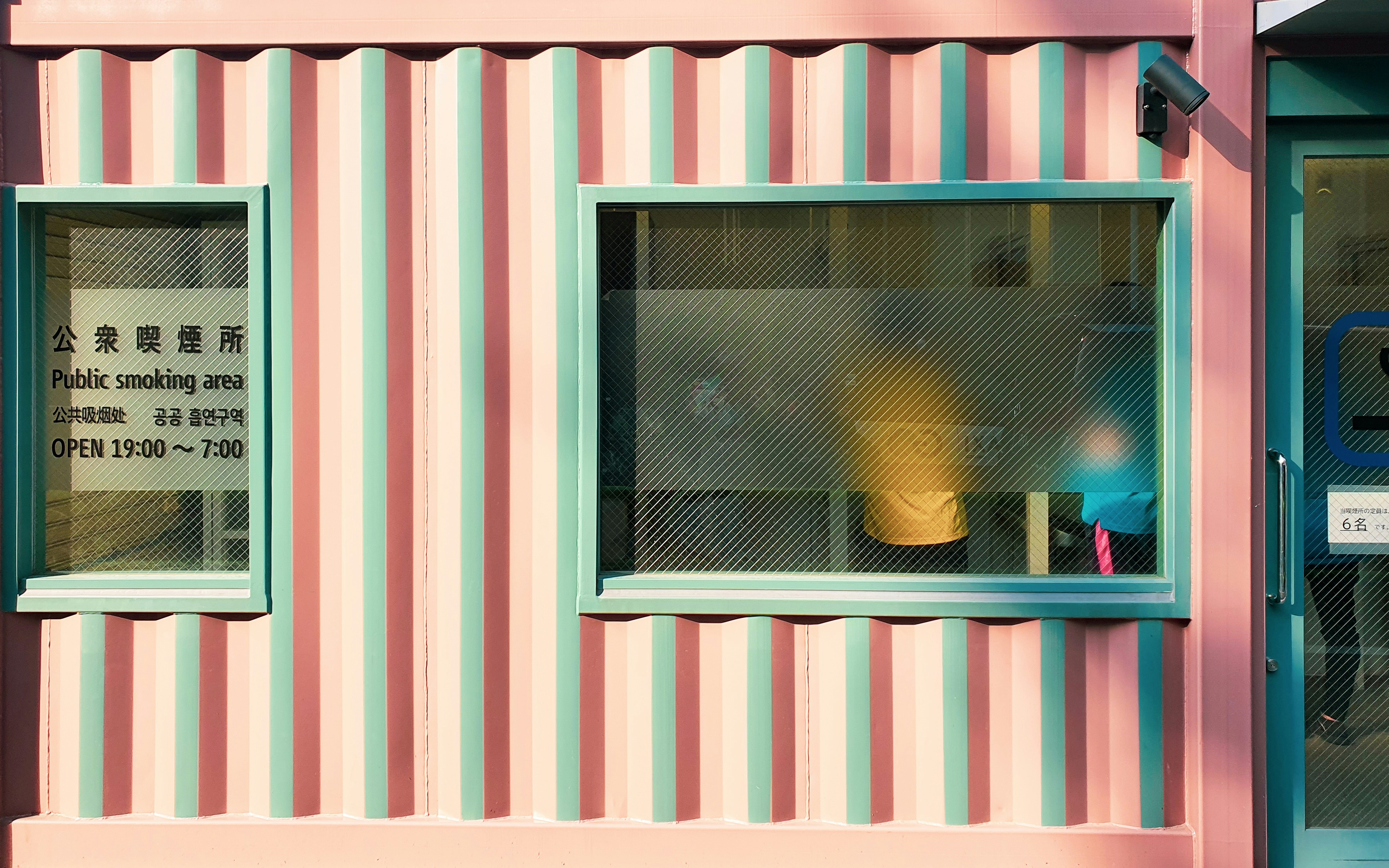 A pink and green building with two windows photo – Free Outdoors Image ...