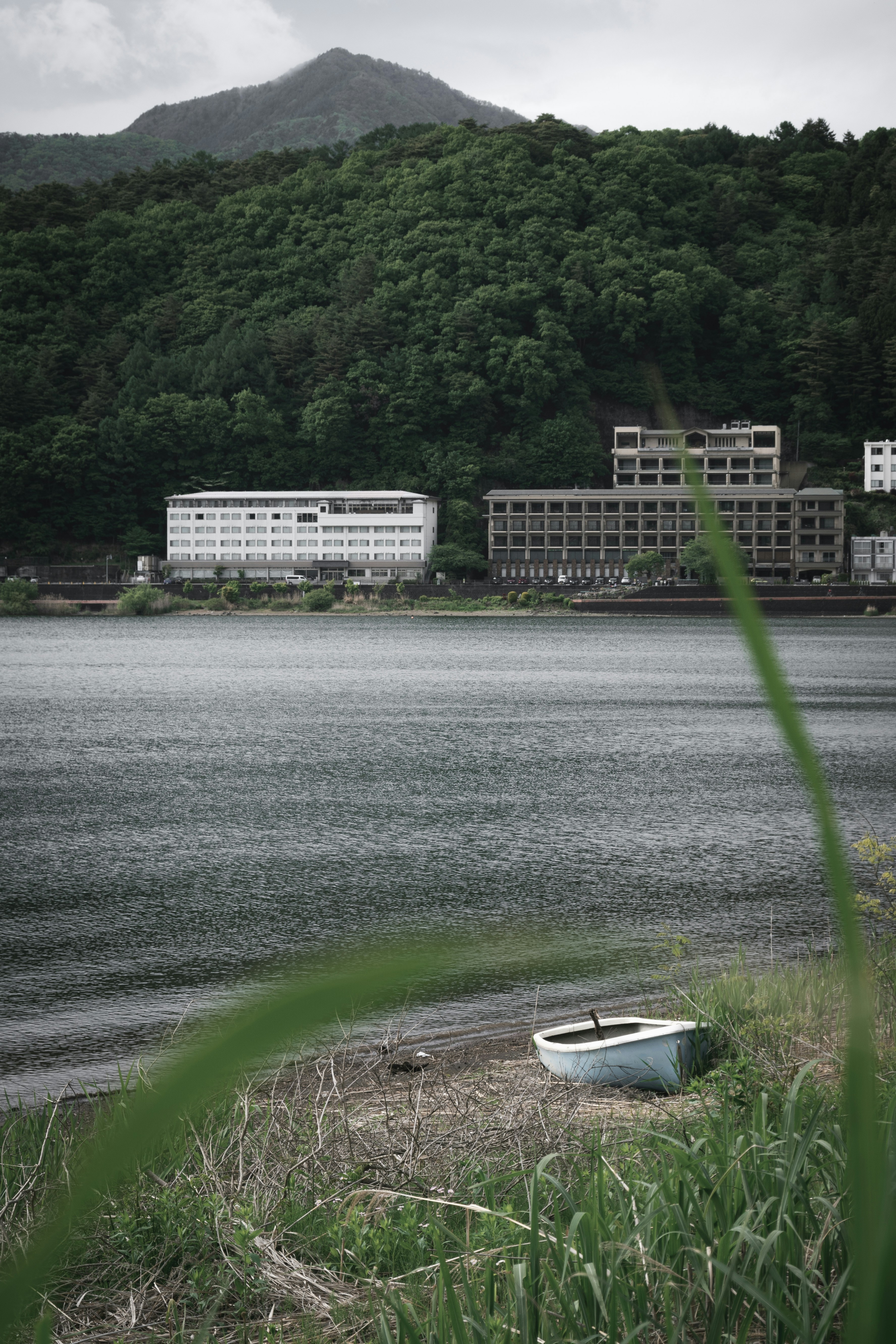 Lakeside Silhouette: Forested Hills Behind a Quiet Waterfront