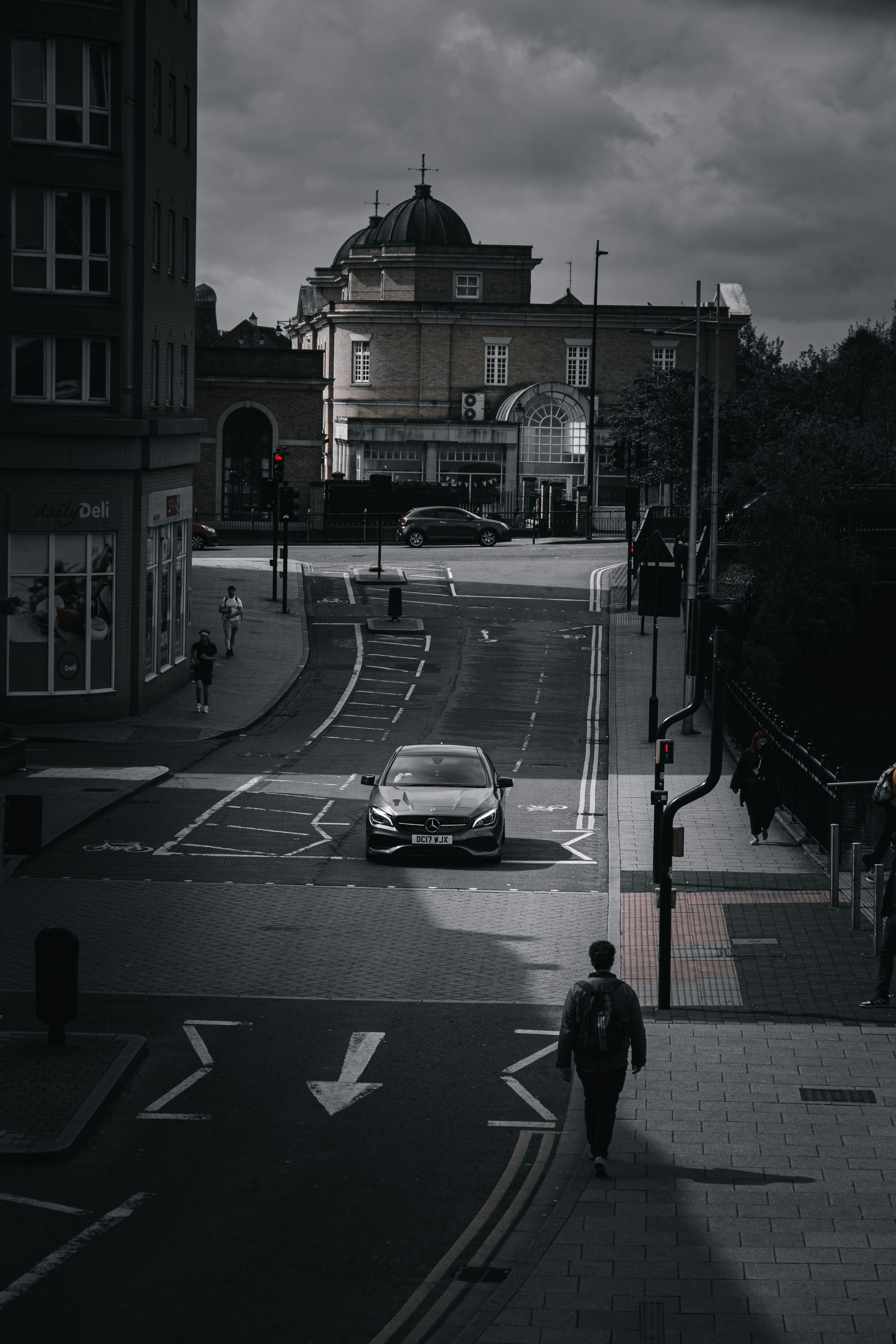 Monochrome Crossroads: The Mercedes at a Quiet City Intersection