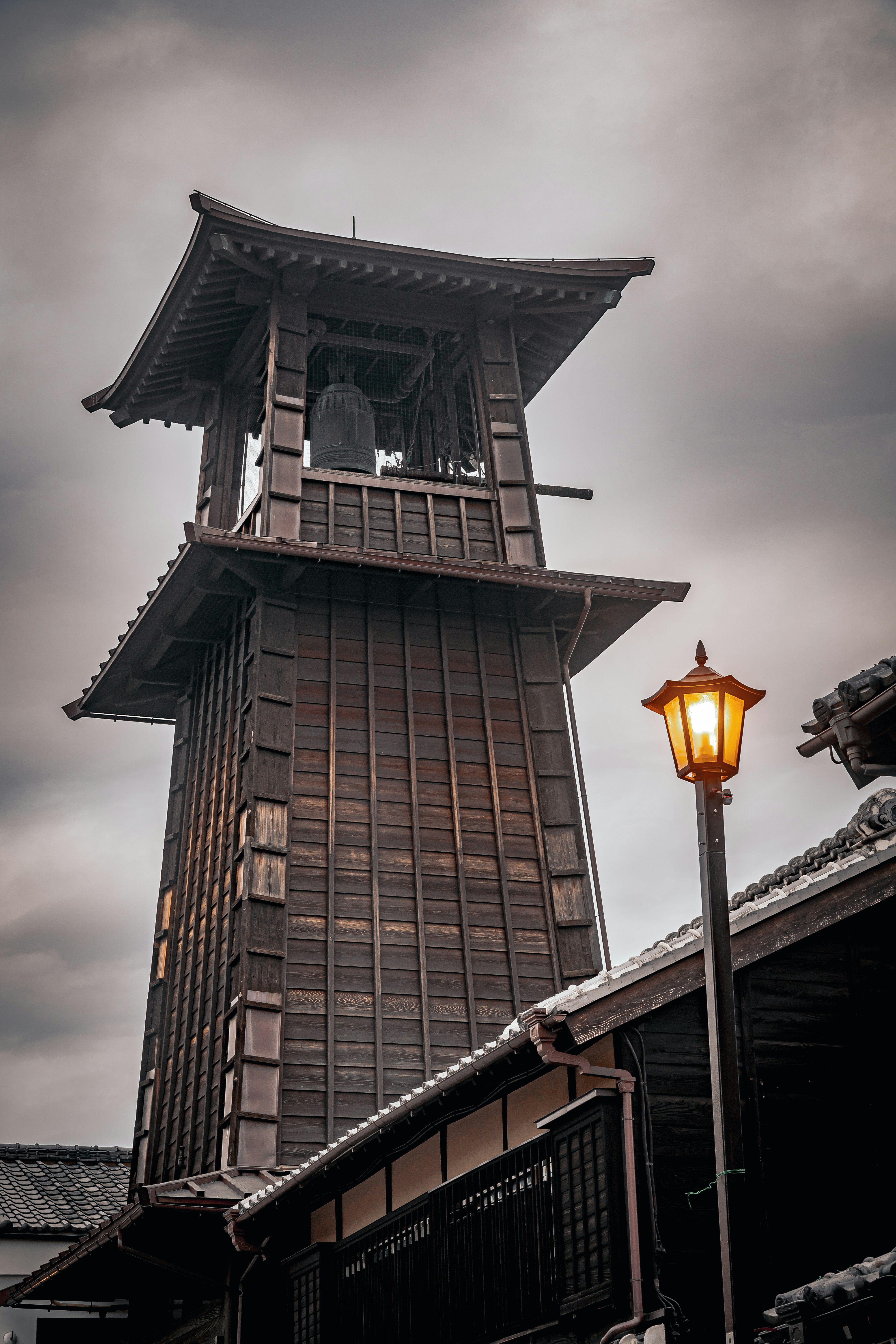 Weathered Bell Tower Rising Under a Moody Sky
