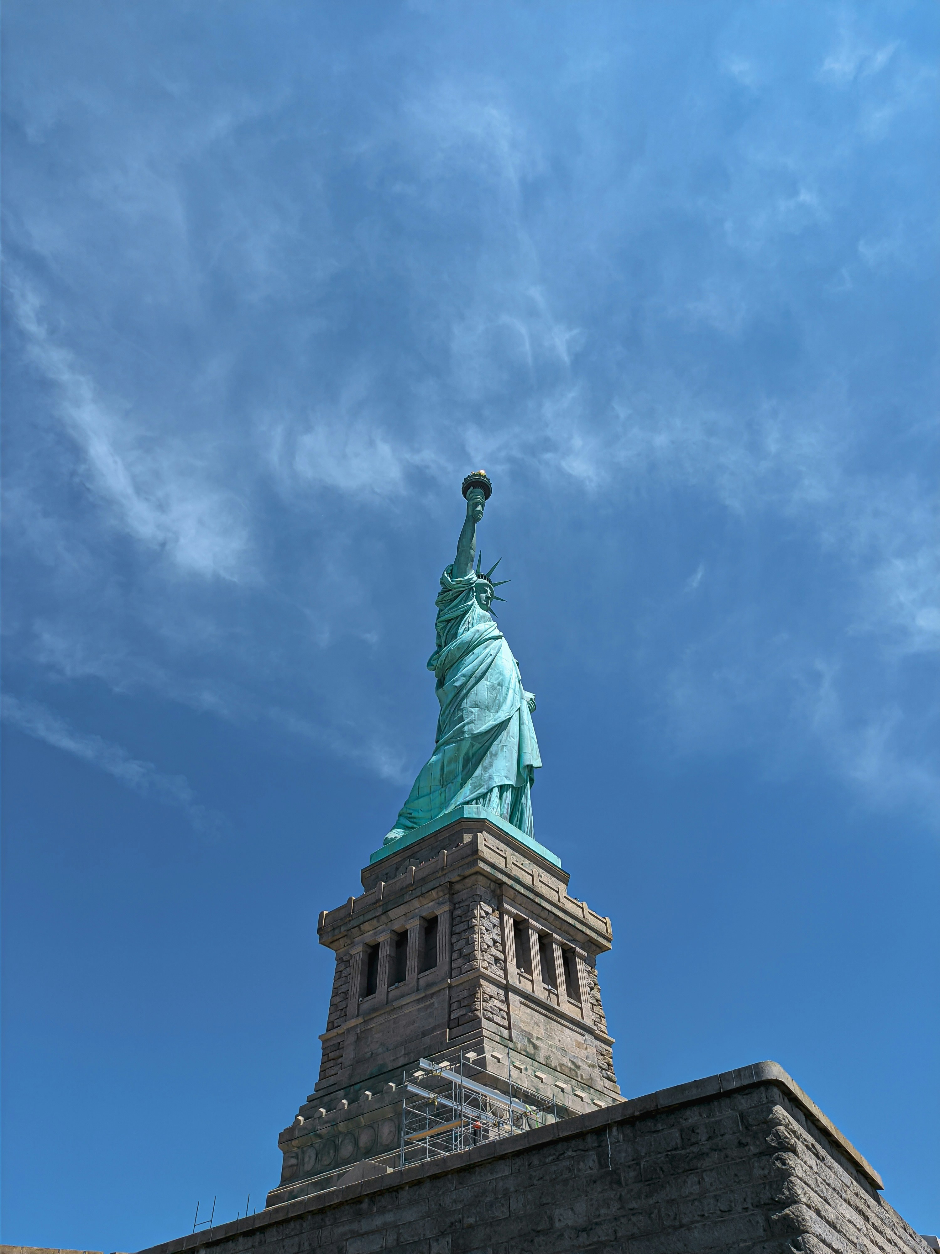 A view of the statue of liberty from the top of a building photo – Free ...