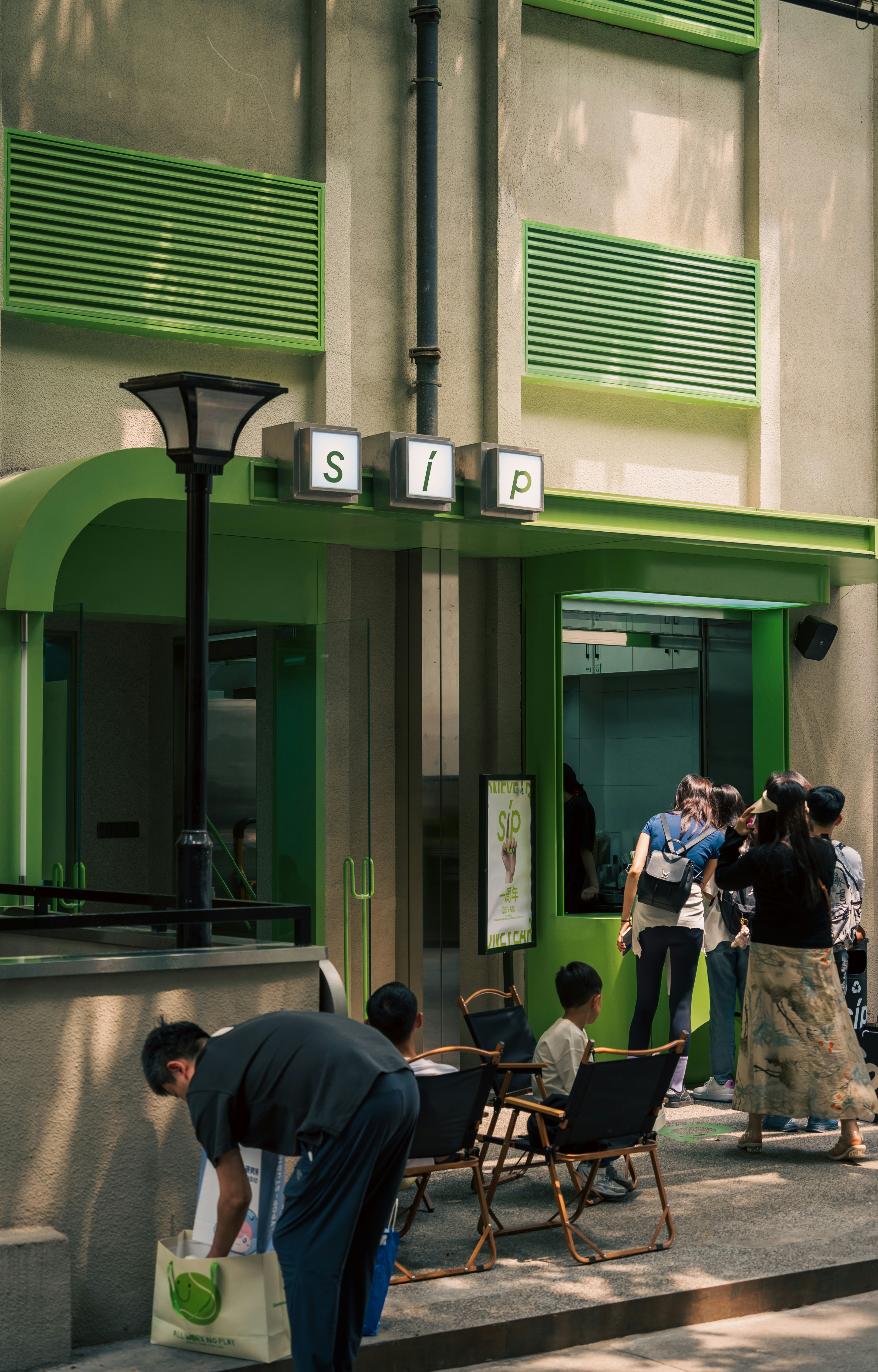 A group of people standing outside of a building photo – Free Woman ...