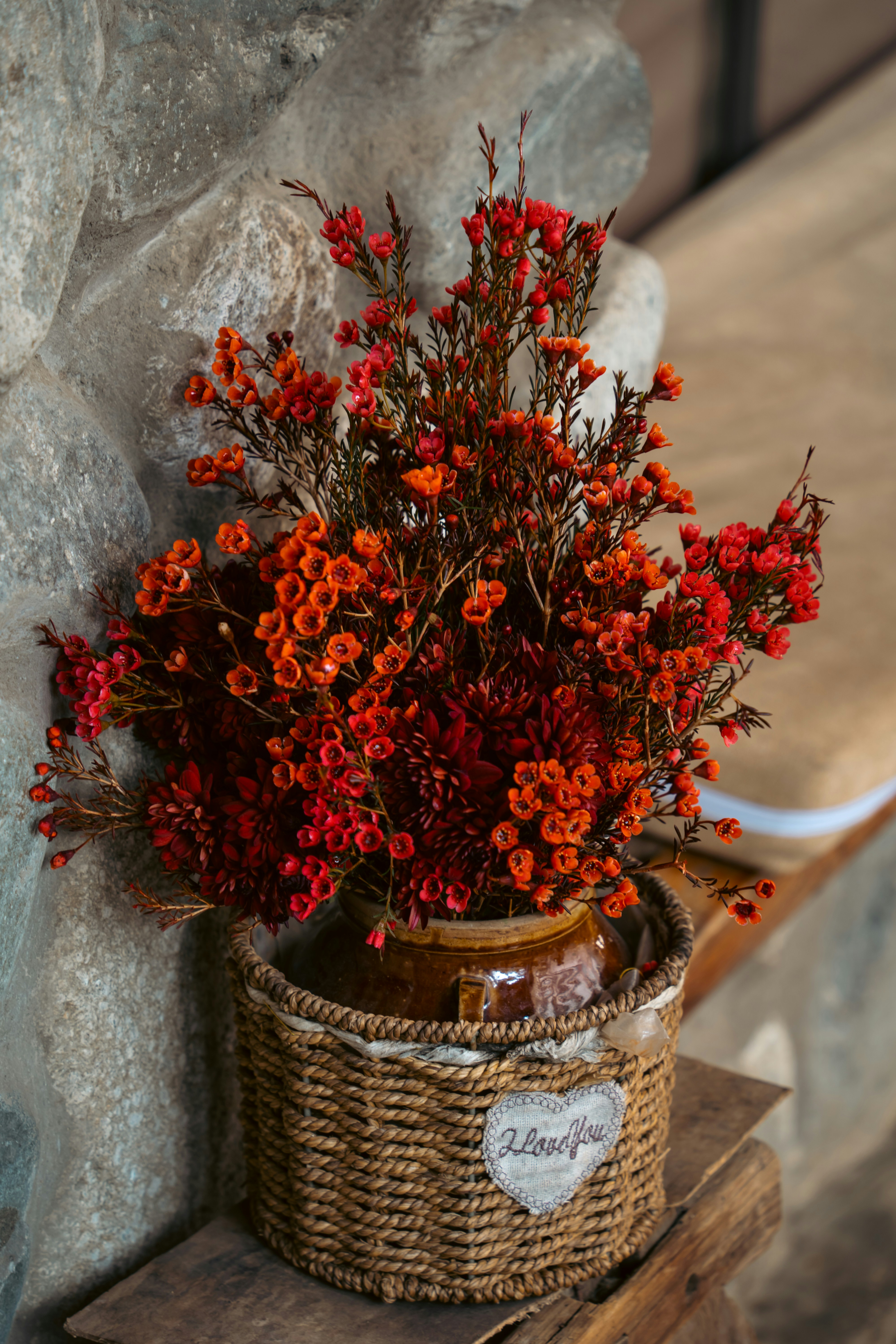 Rustic Ember Bouquet: A Woven Jar of Red-Orange Blooms