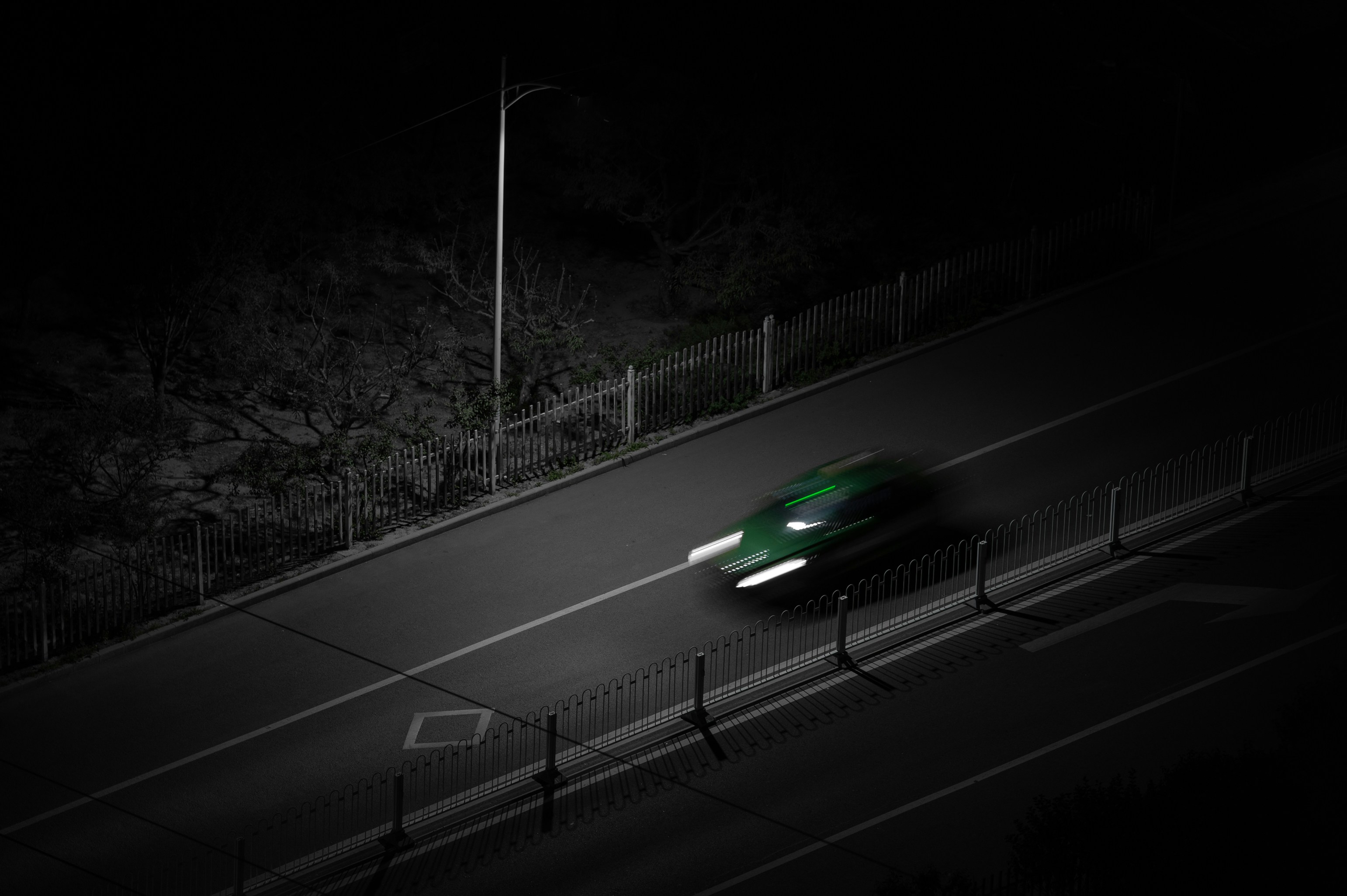 Midnight Green Streak on a Dim Boulevard