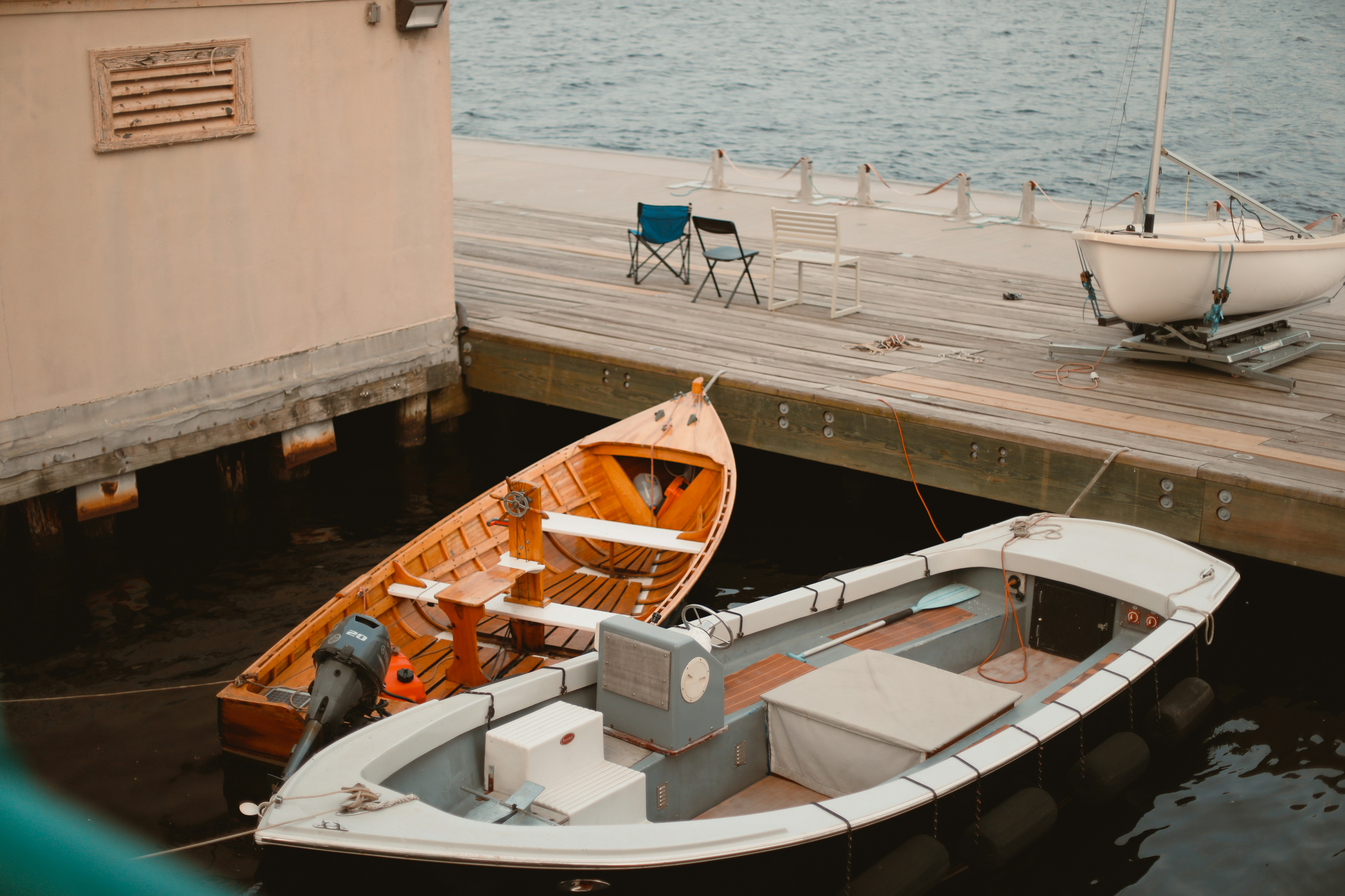 A small wooden boat tied to a dock photo – Free Water Image on Unsplash