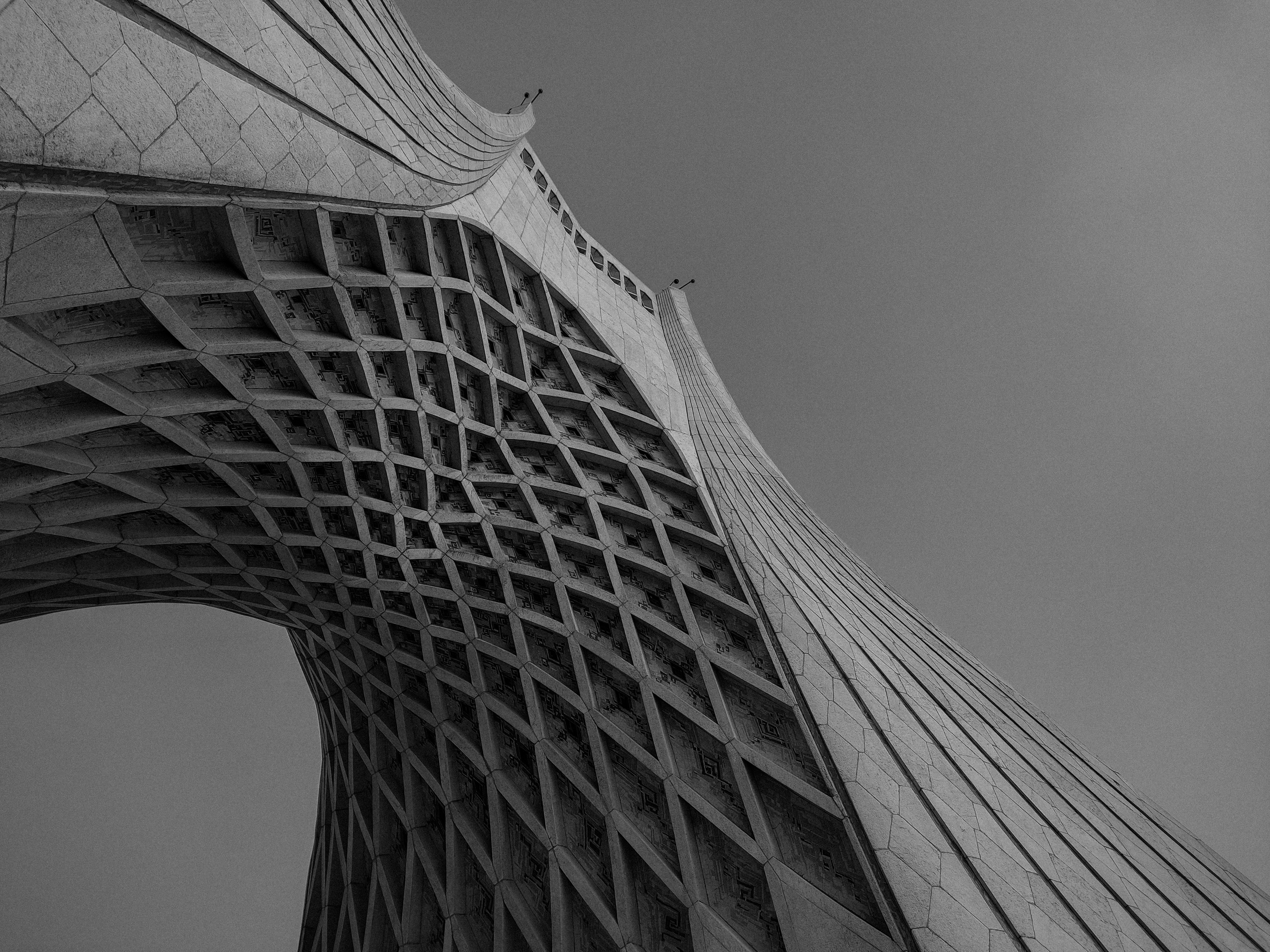 Monochrome Lattice Arch: A Curved Grid in Concrete Light