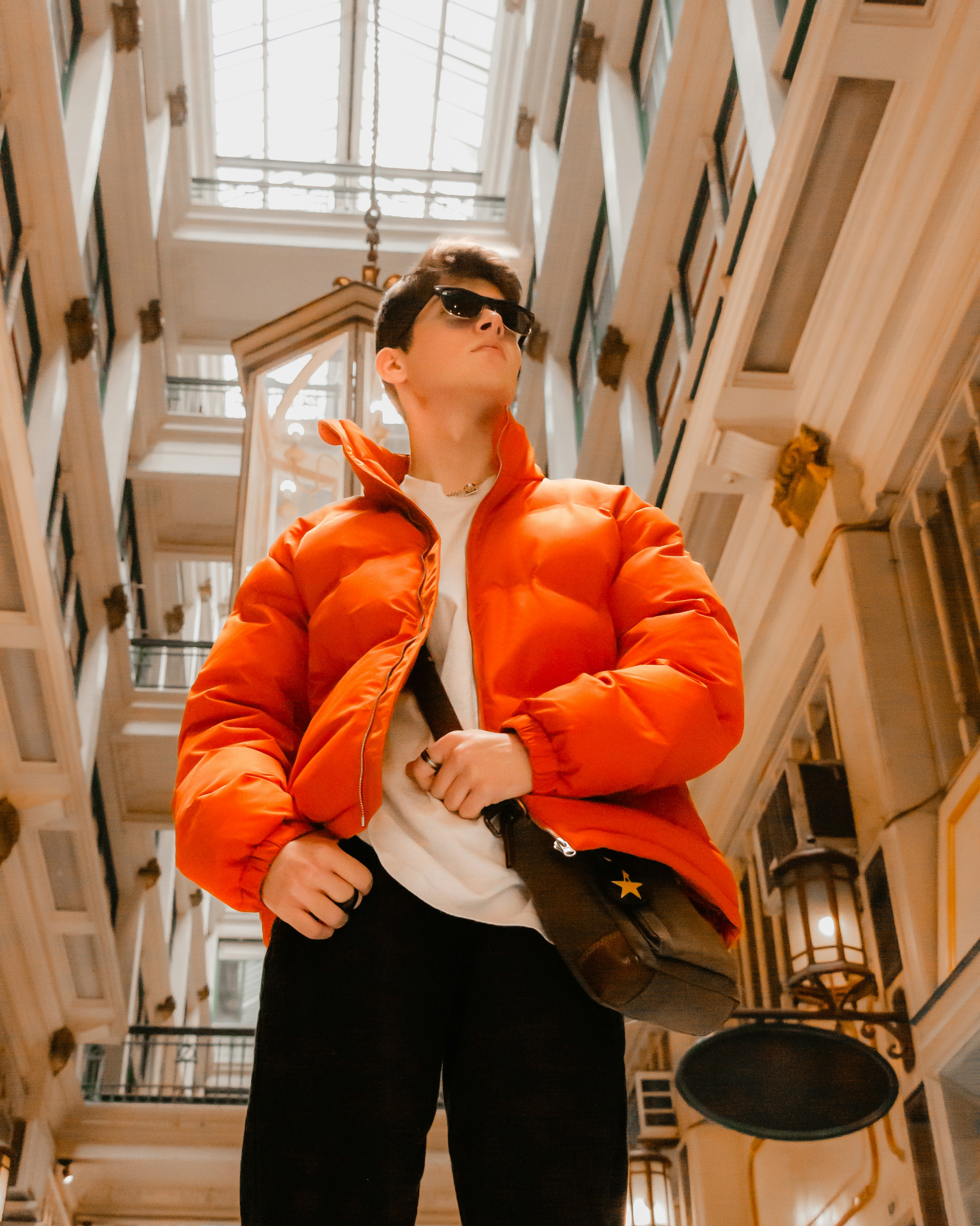 A man in an orange puffer jacket and black pants photo – Free Auckland ...