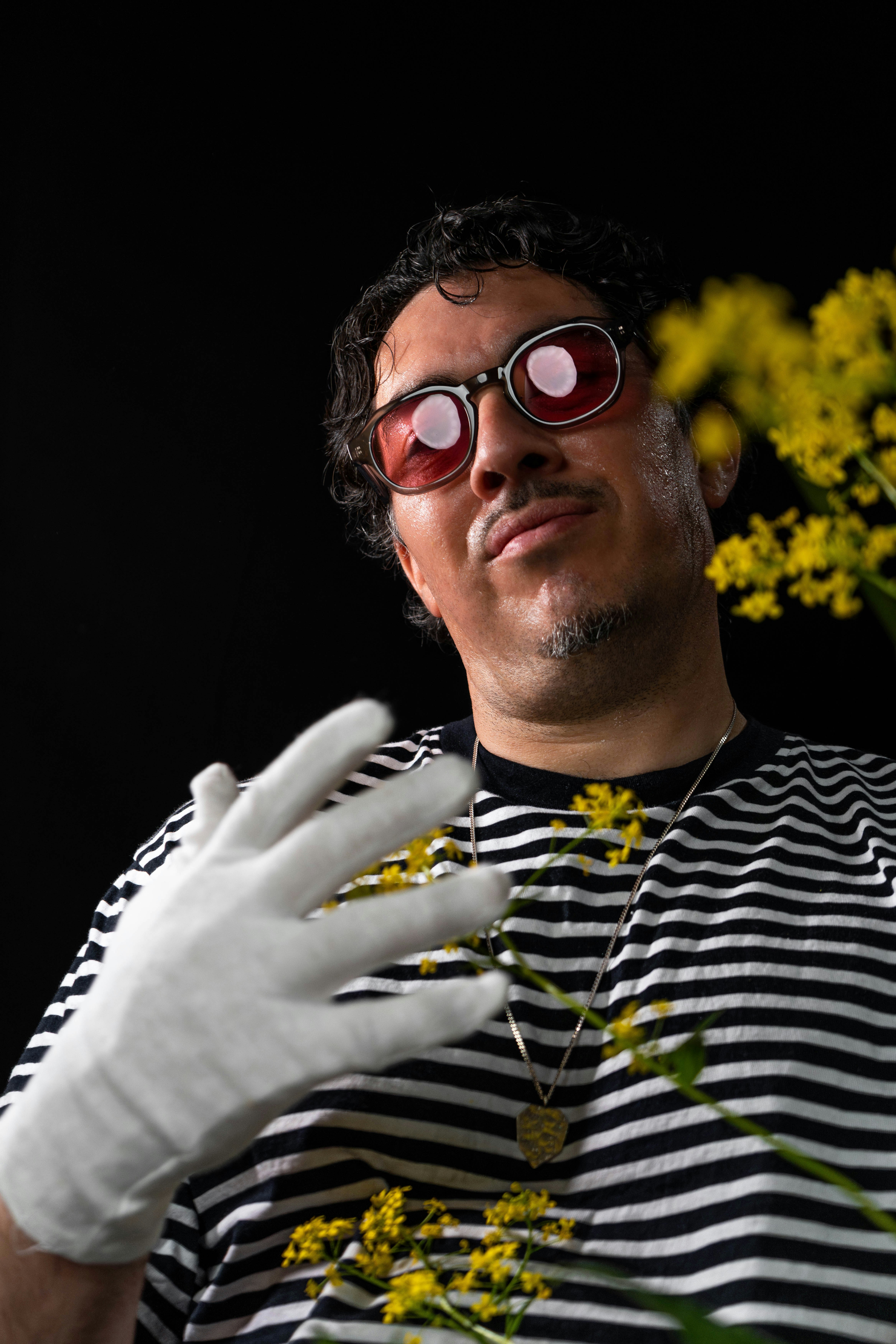 Gloved Portrait Amid Stripes and Yellow Bloom