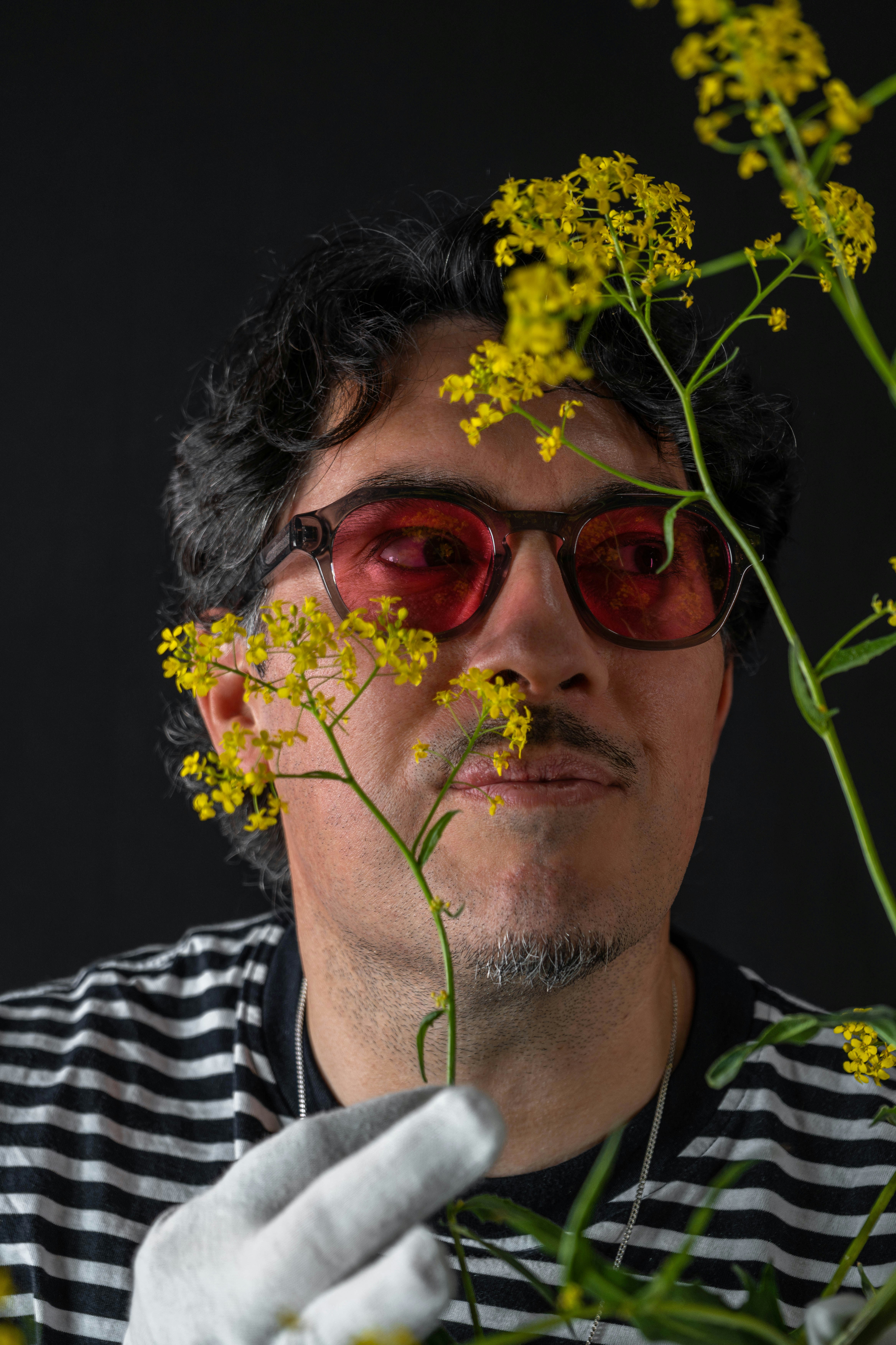 Crimson Lenses and Golden Stems: A Studio Portrait Framed by Spring