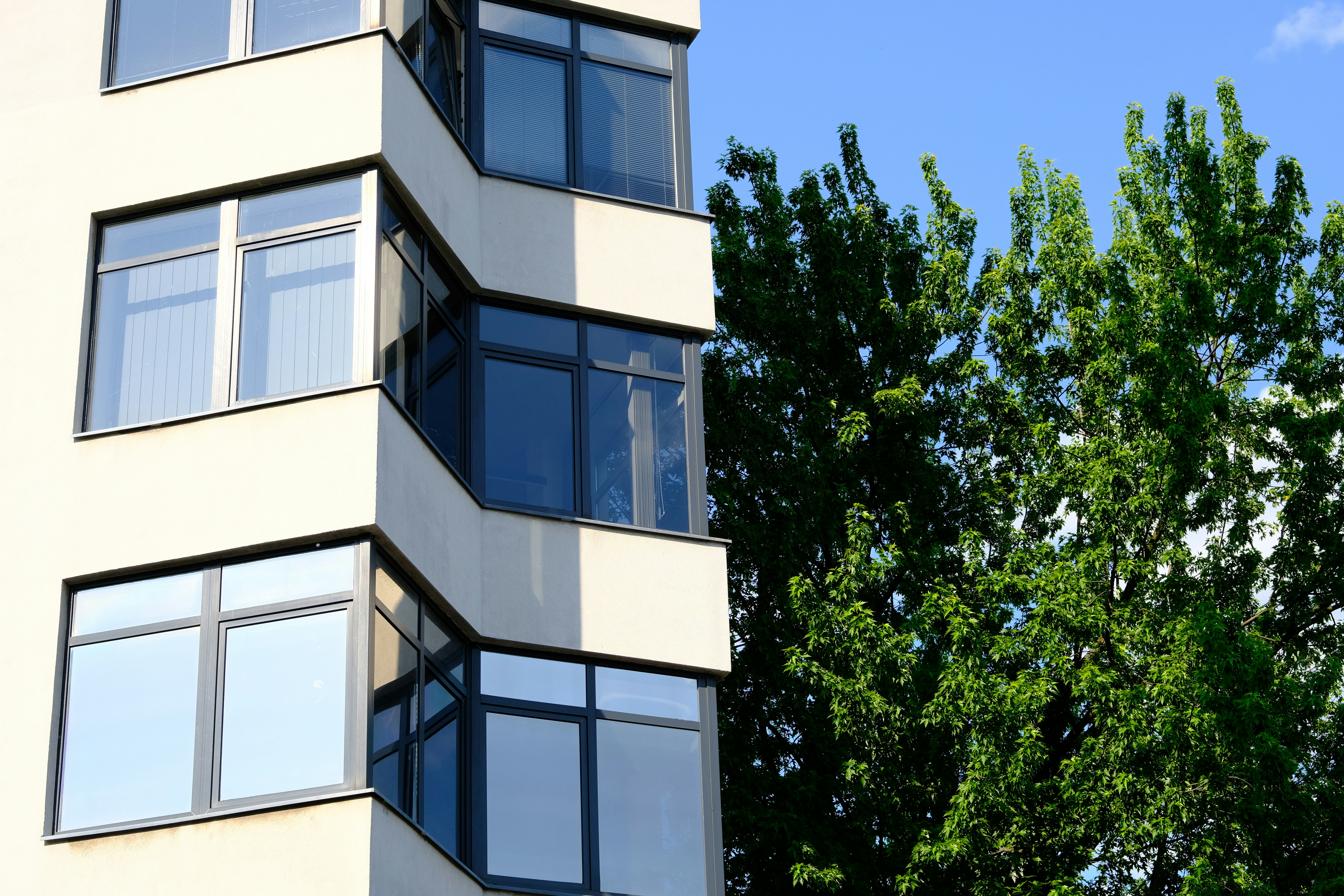 A tall white building with lots of windows photo – Free Building Image ...