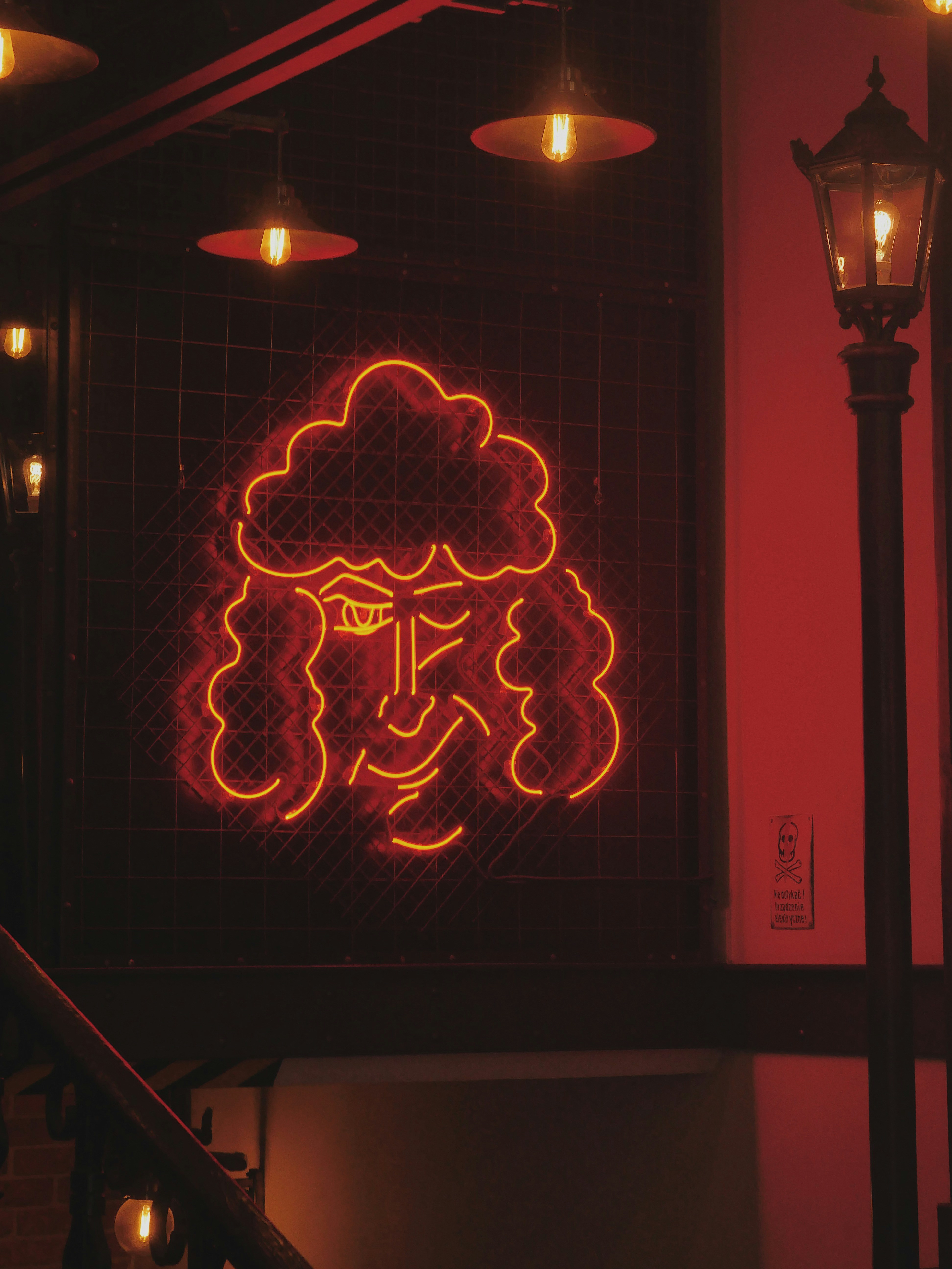 A neon sign that is on the side of a building photo – Free Warsaw Image ...