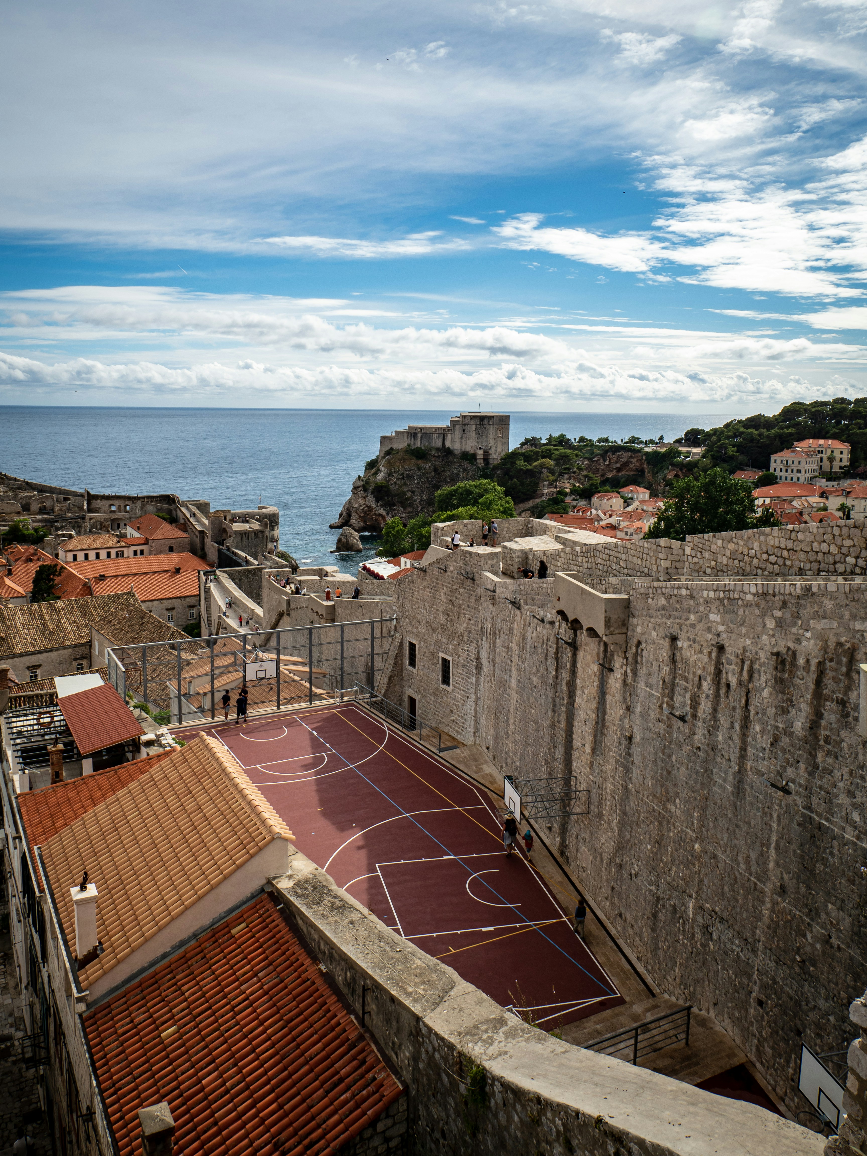 Red Court Beneath the Citadel: A Fortress Basketball Court by the Sea