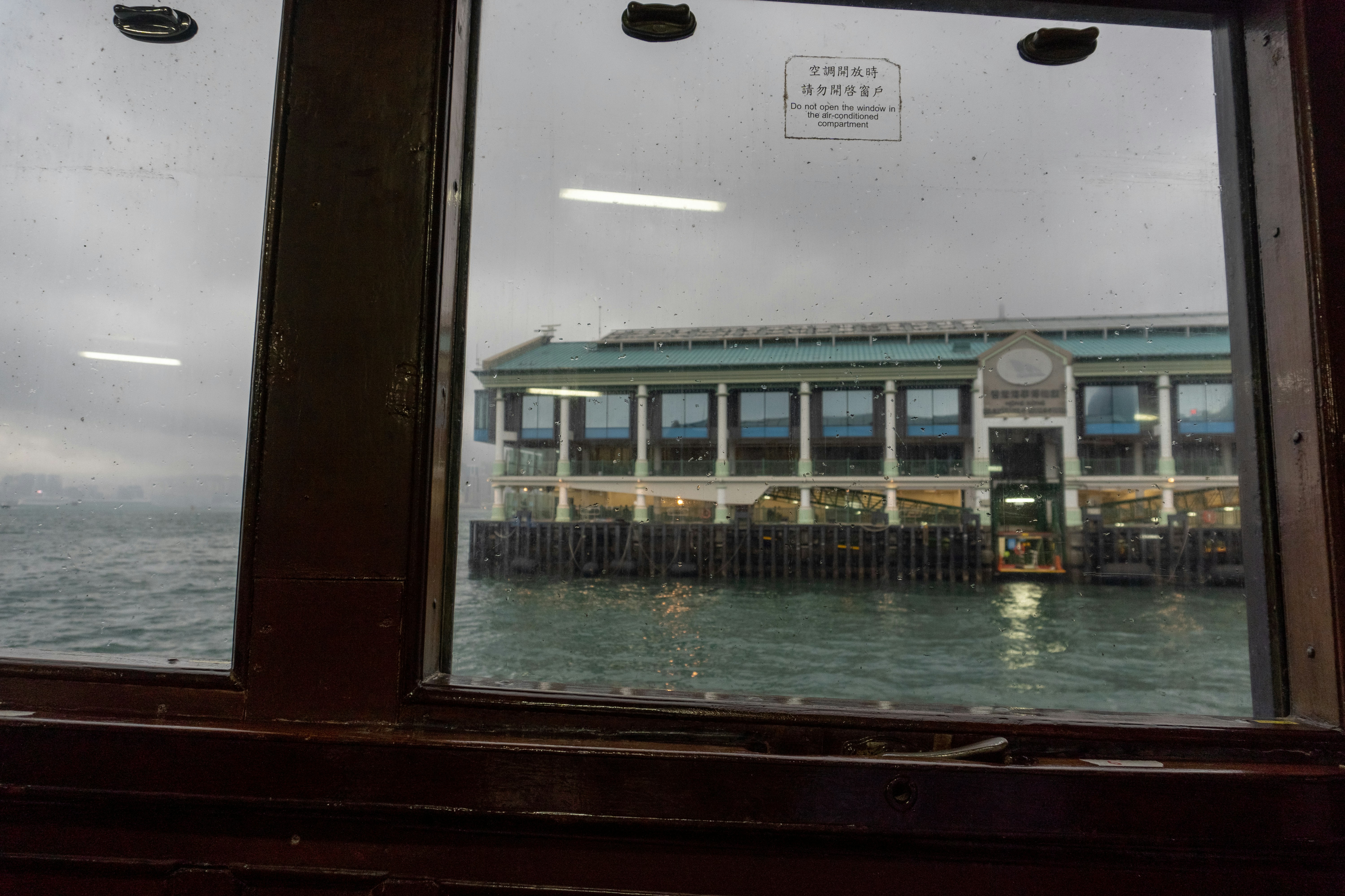 Harbor View Through a Porthole: Coastal Building and Pier