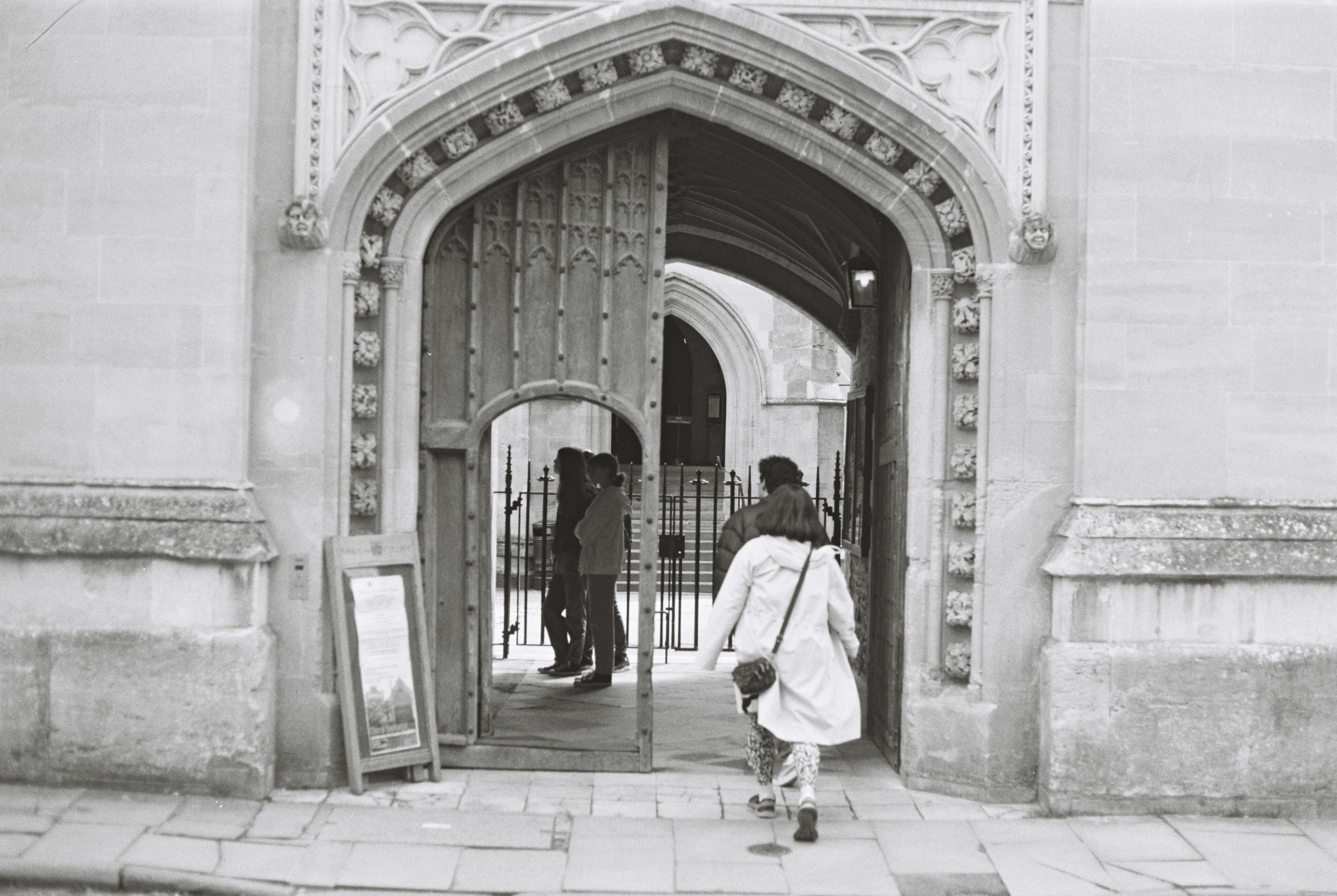 A black and white photo of people entering a building photo – Free Uk ...