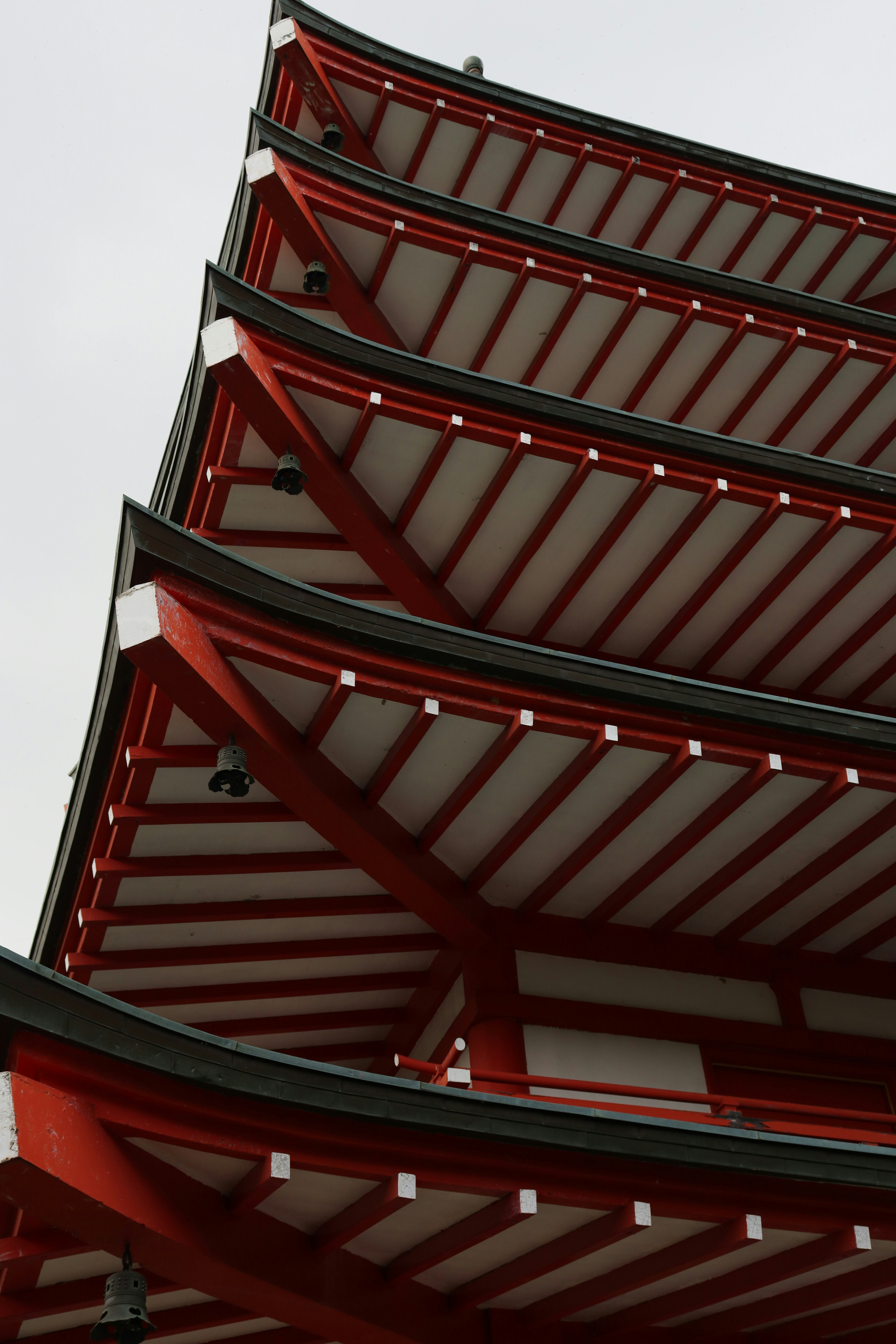 Crimson Tiers in Focus: A Close-Up of a Pagoda's Red Timber Eaves