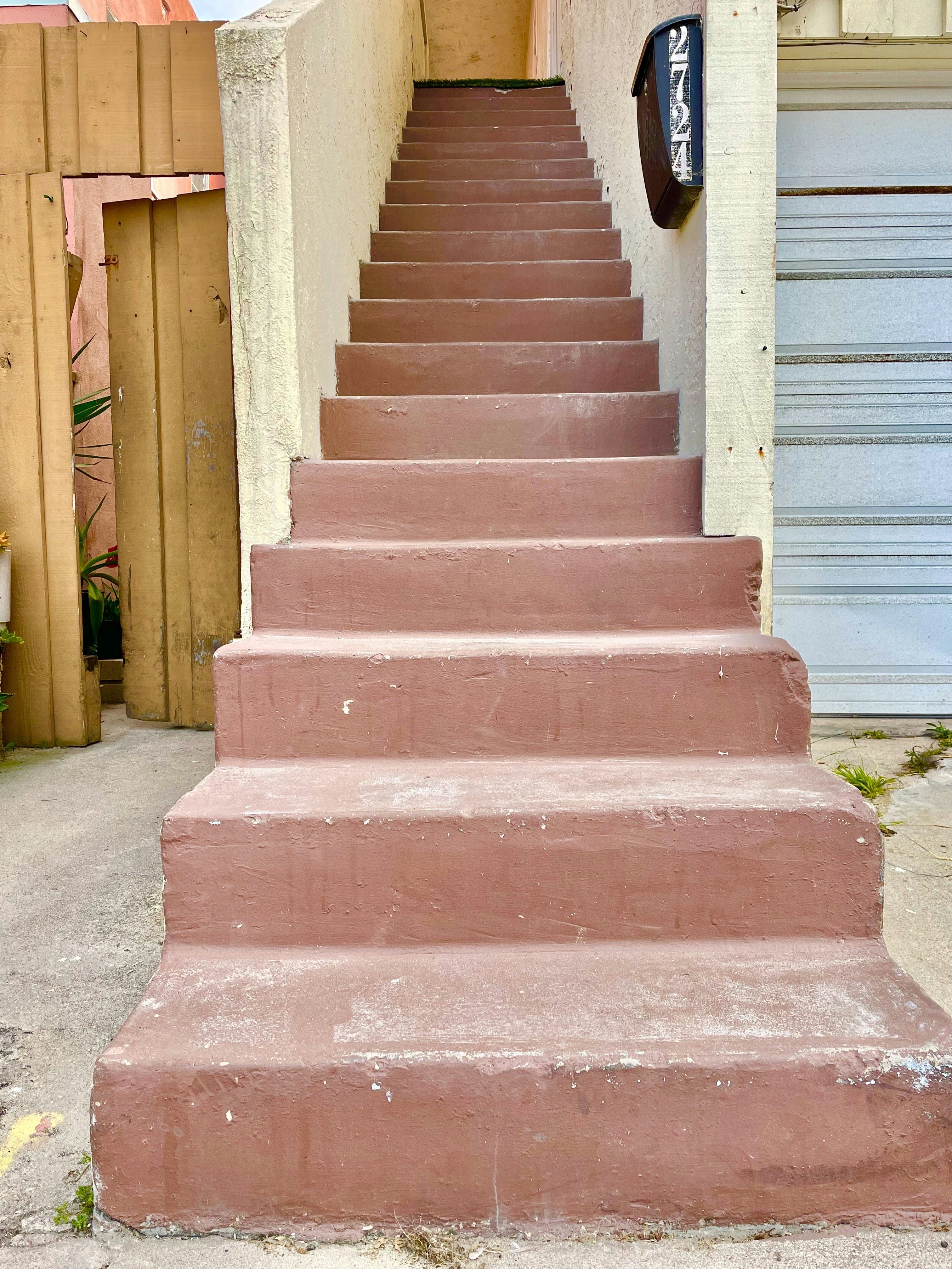 A set of pink steps leading up to a garage photo – Free Image on Unsplash