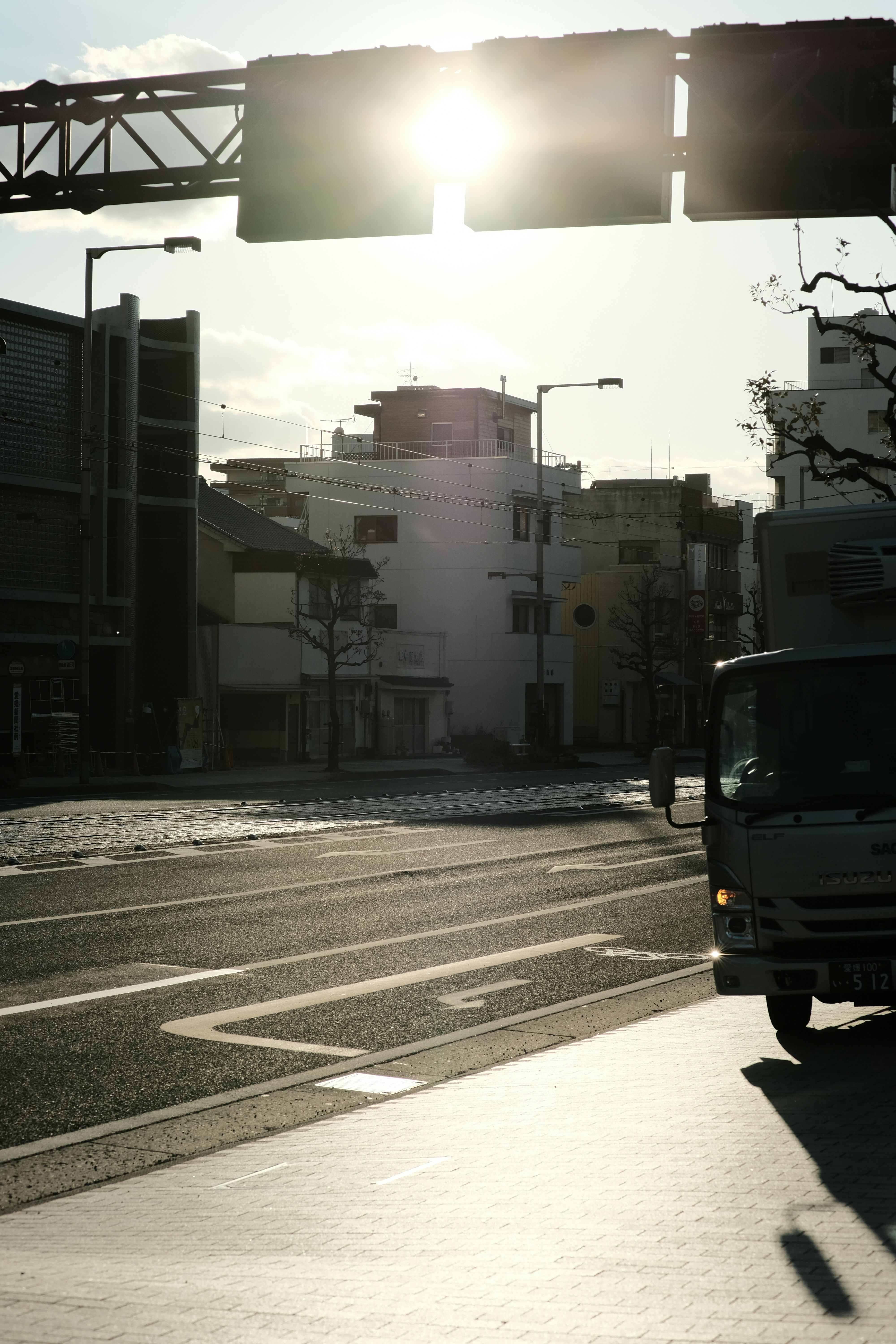 Sunflare at the Crossroads: A Quiet Urban Morning Beyond the Overpass