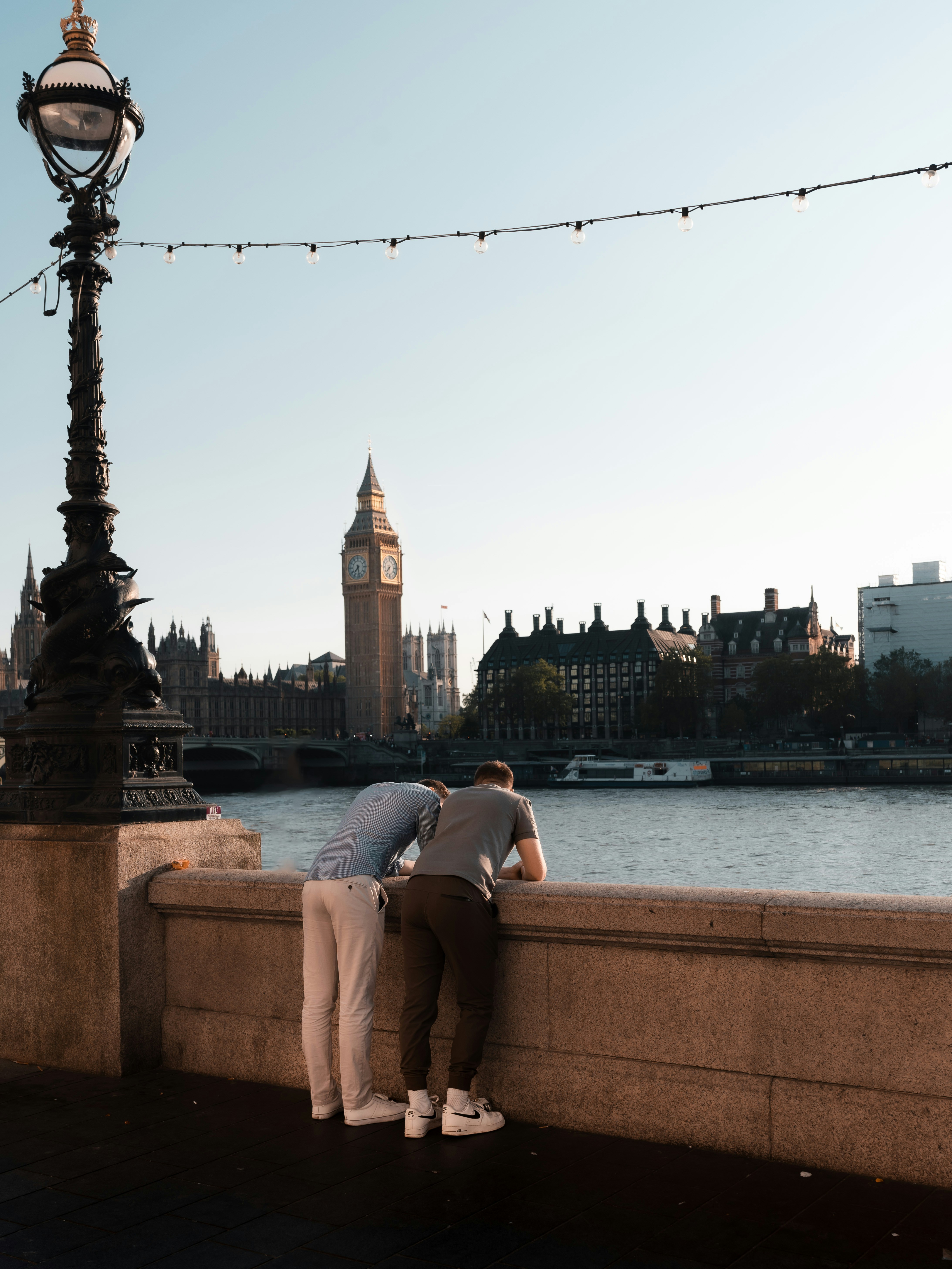 Thames Glow: Two Friends at Westminster Riverside at Dusk