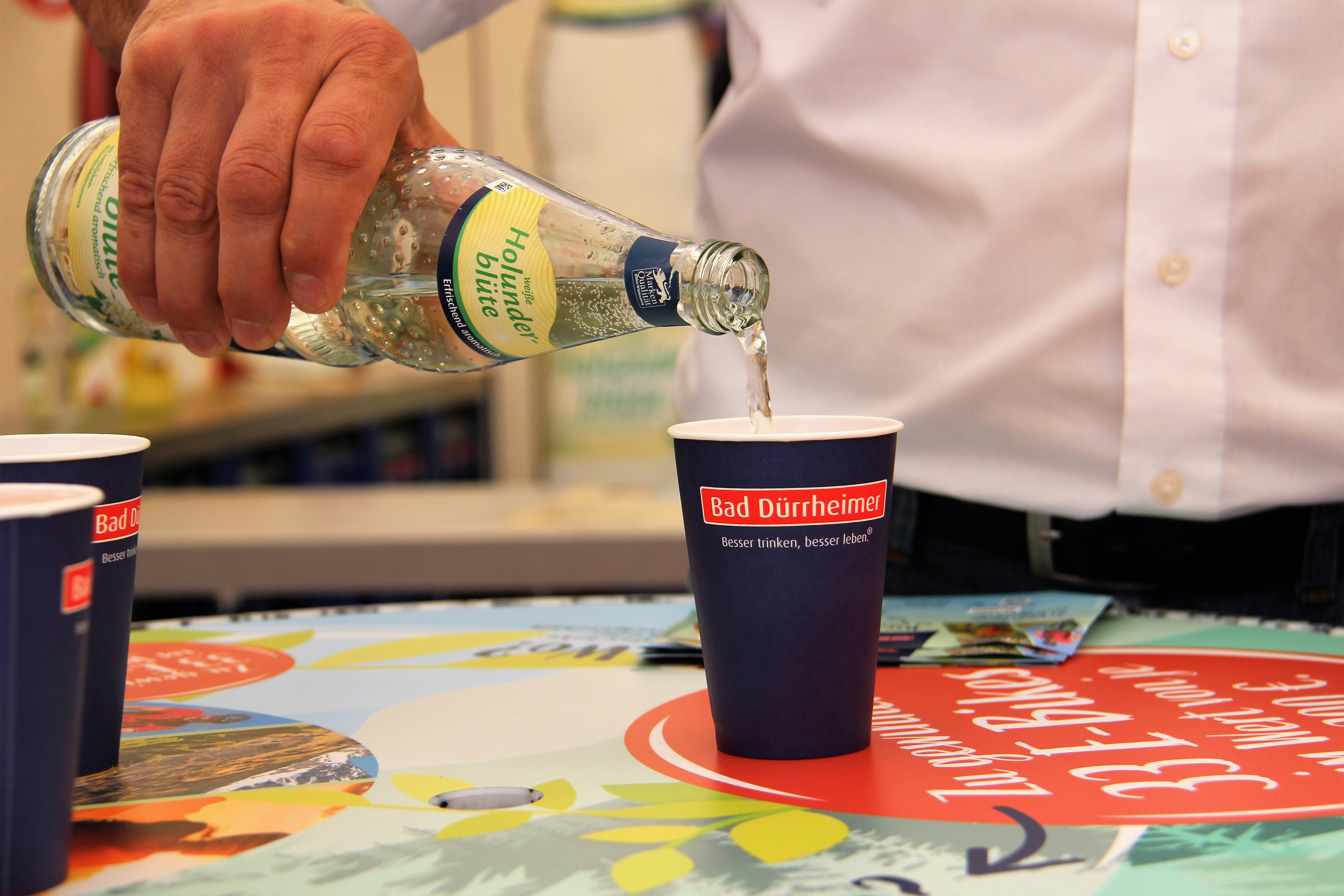 Pouring Flavor: A Careful Pour into a Dark Cup at a Colorful Tablescape