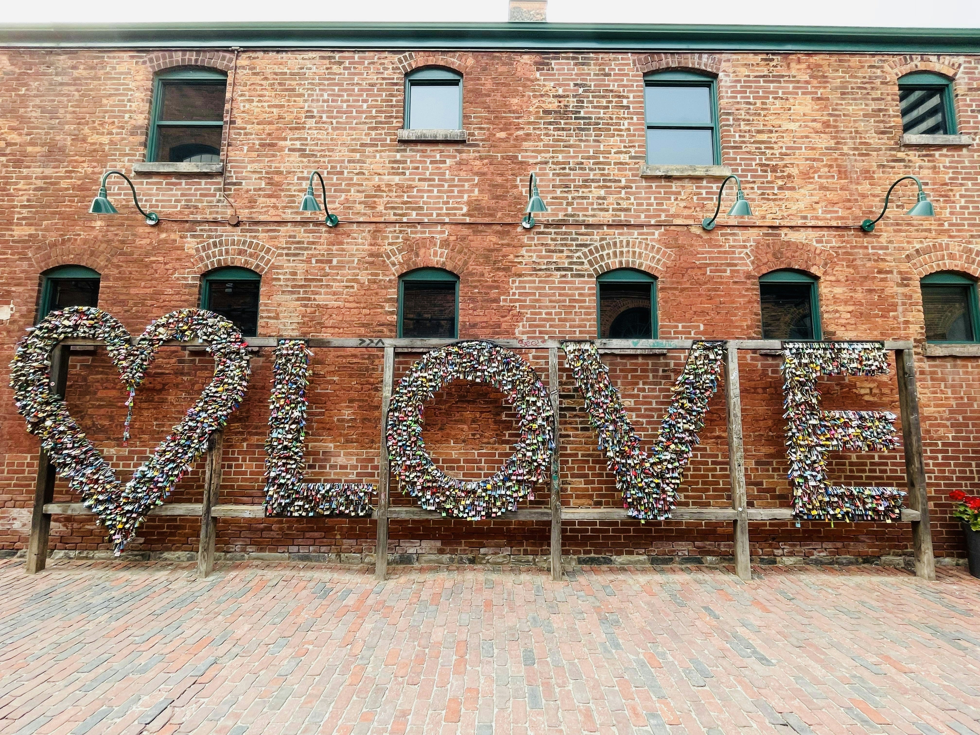 A brick building with the word love spelled out photo – Free Spirit of ...