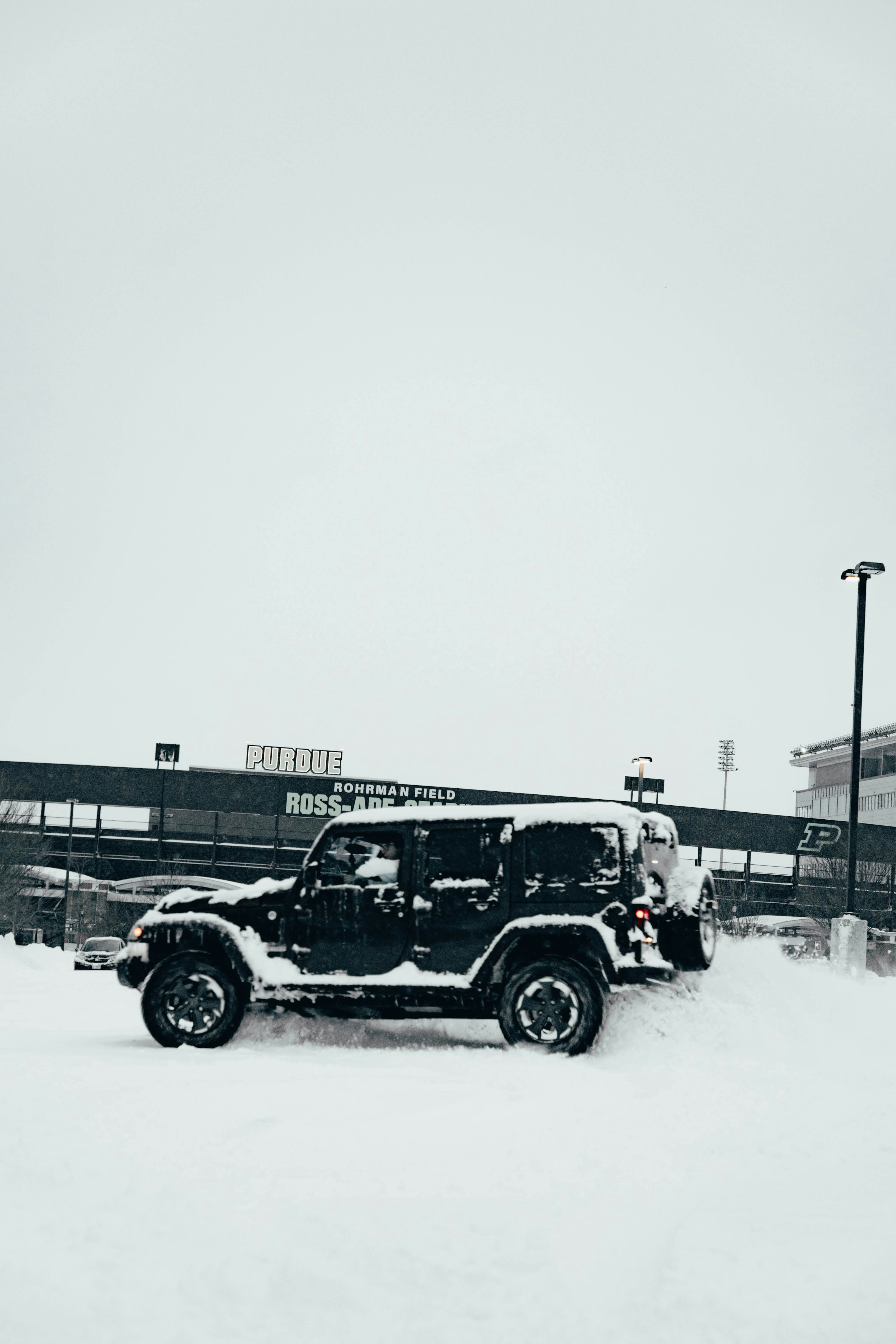 Snow-Swept Jeep Anchored in Purdue’s Quiet Parking Lot
