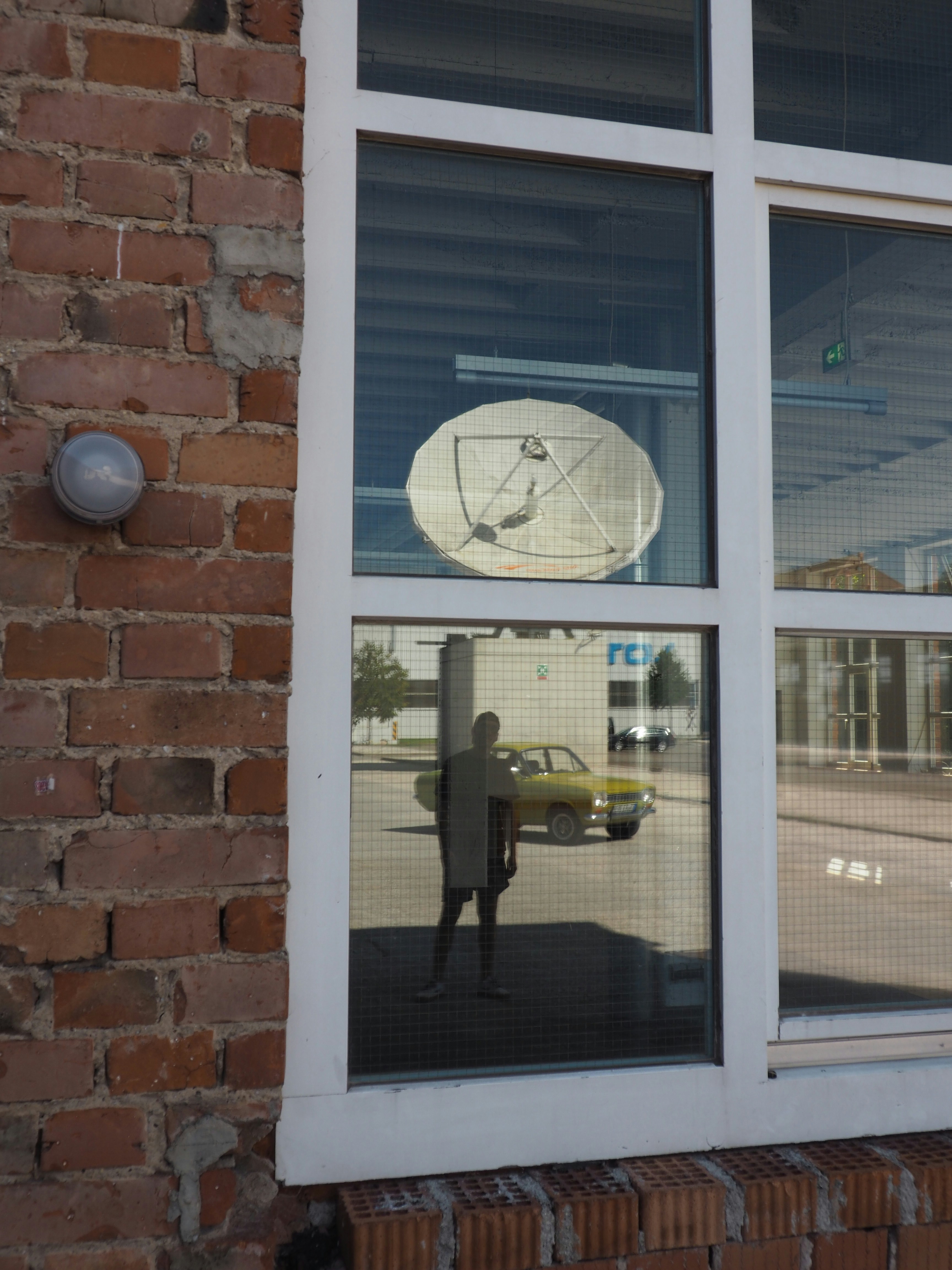 A window with a satellite dish reflected in it photo – Free Image on ...