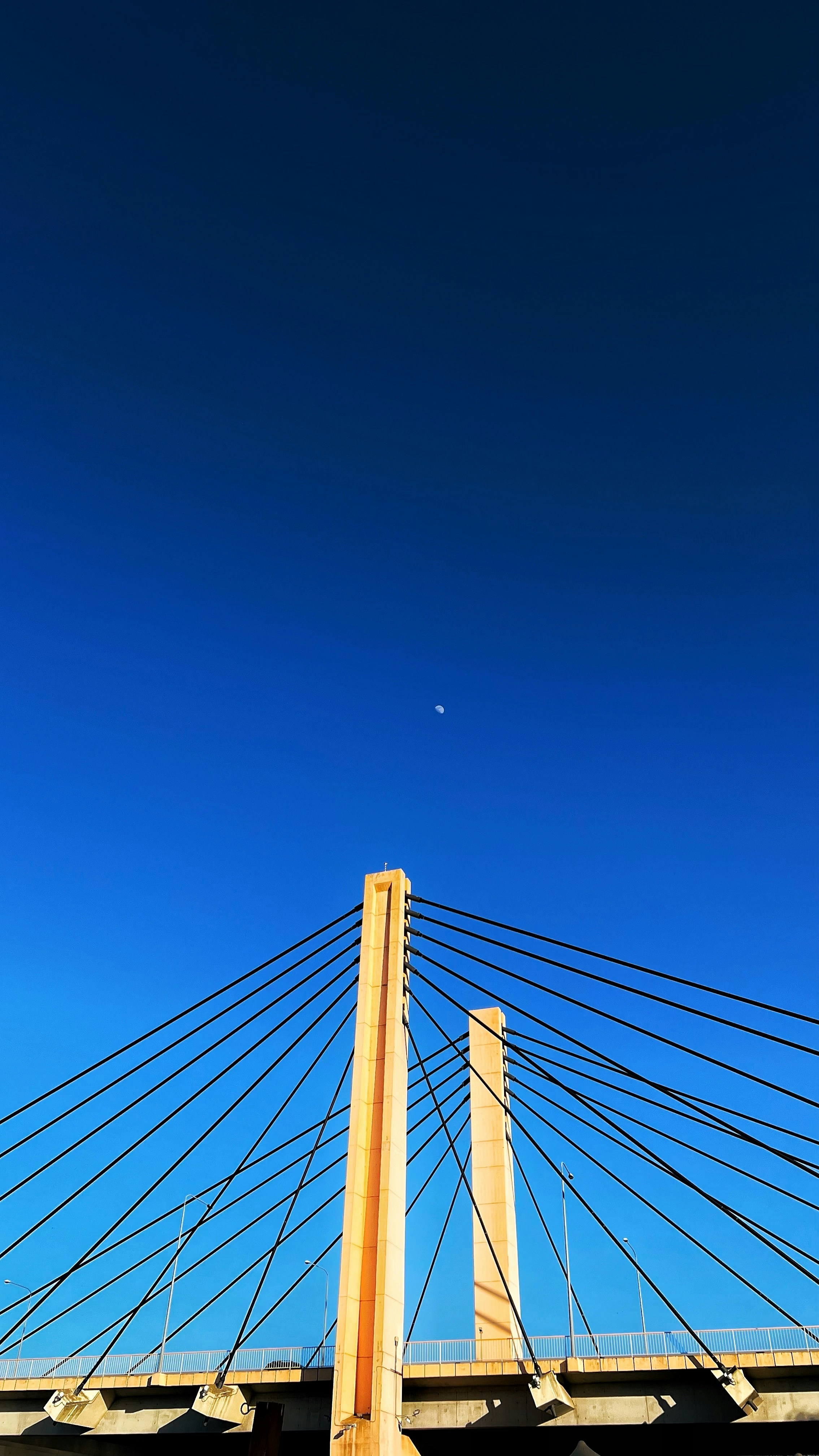 A very tall bridge with a blue sky in the background photo – Free ...