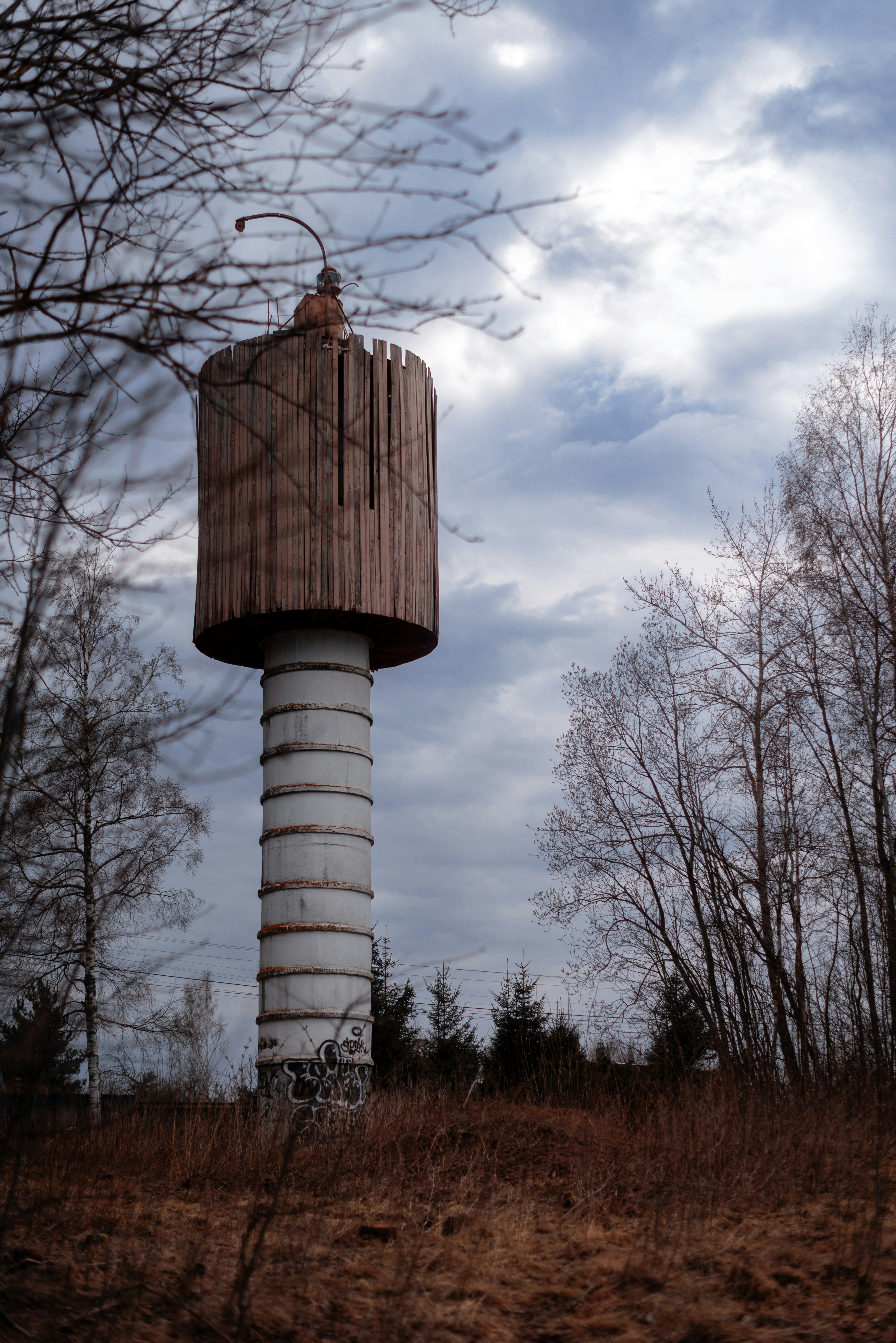 Weathered Sentinel: a lone water tower under a moody winter sky
