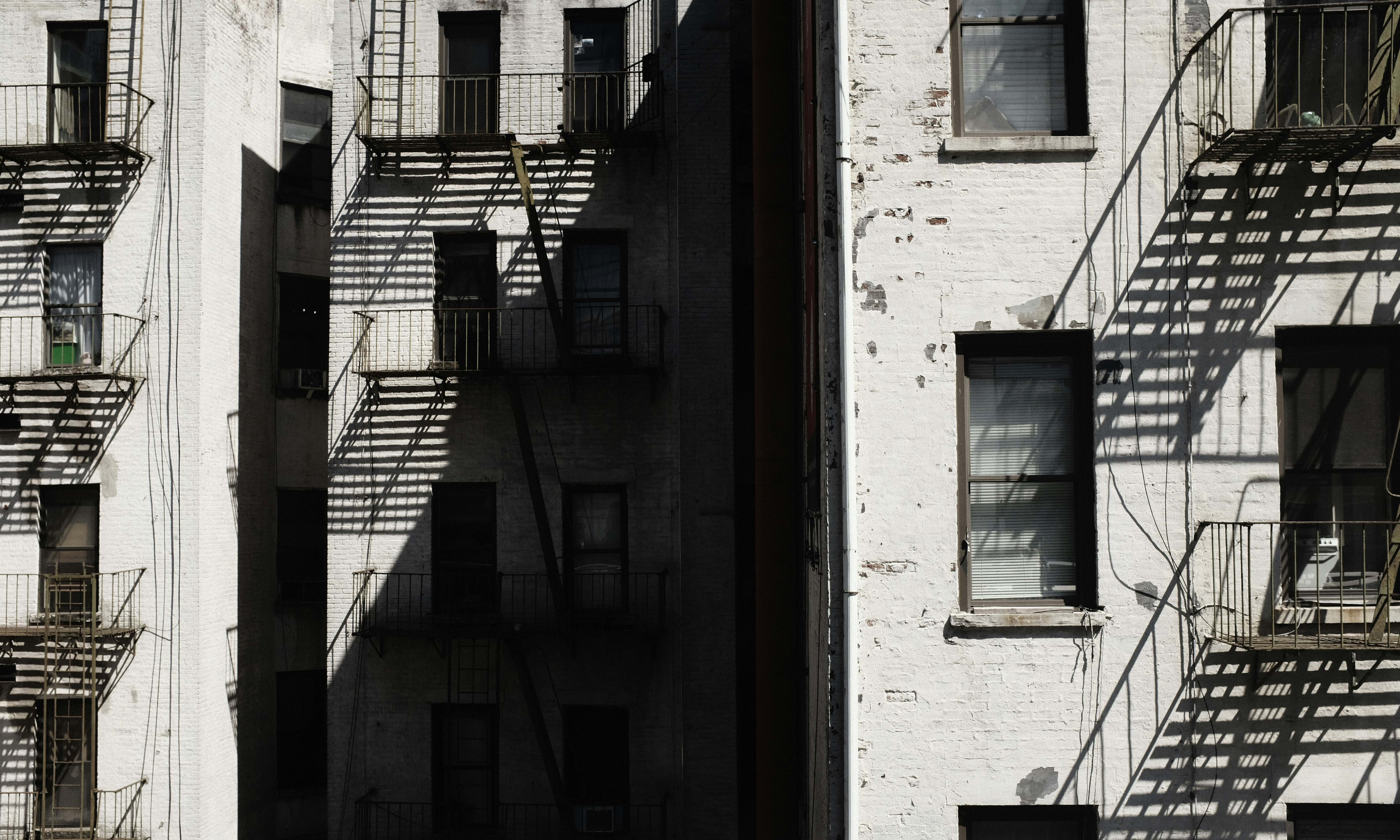 The shadows of a fire escape on a building photo – Free Building Image ...