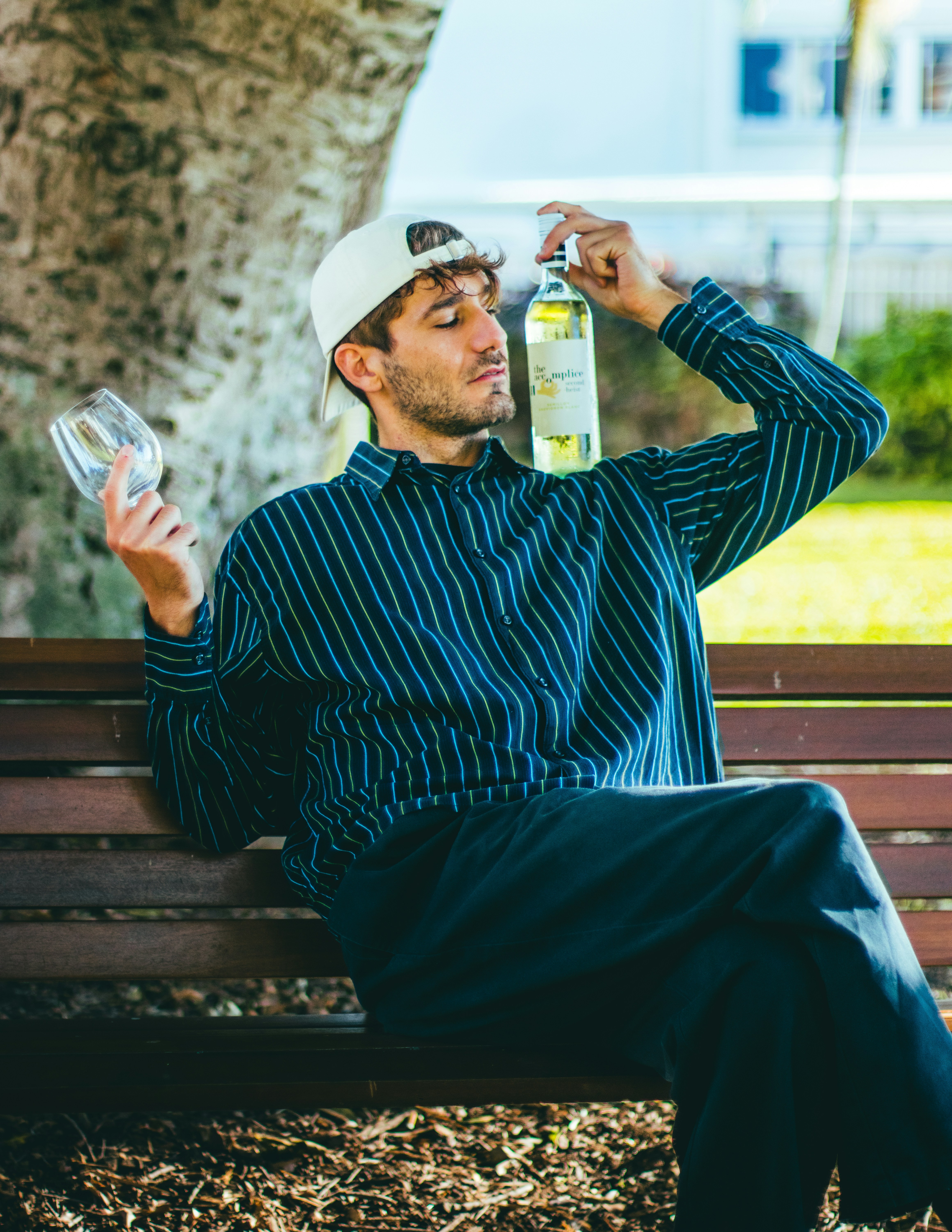 Sipping sunshine: a relaxed street style moment on the park bench