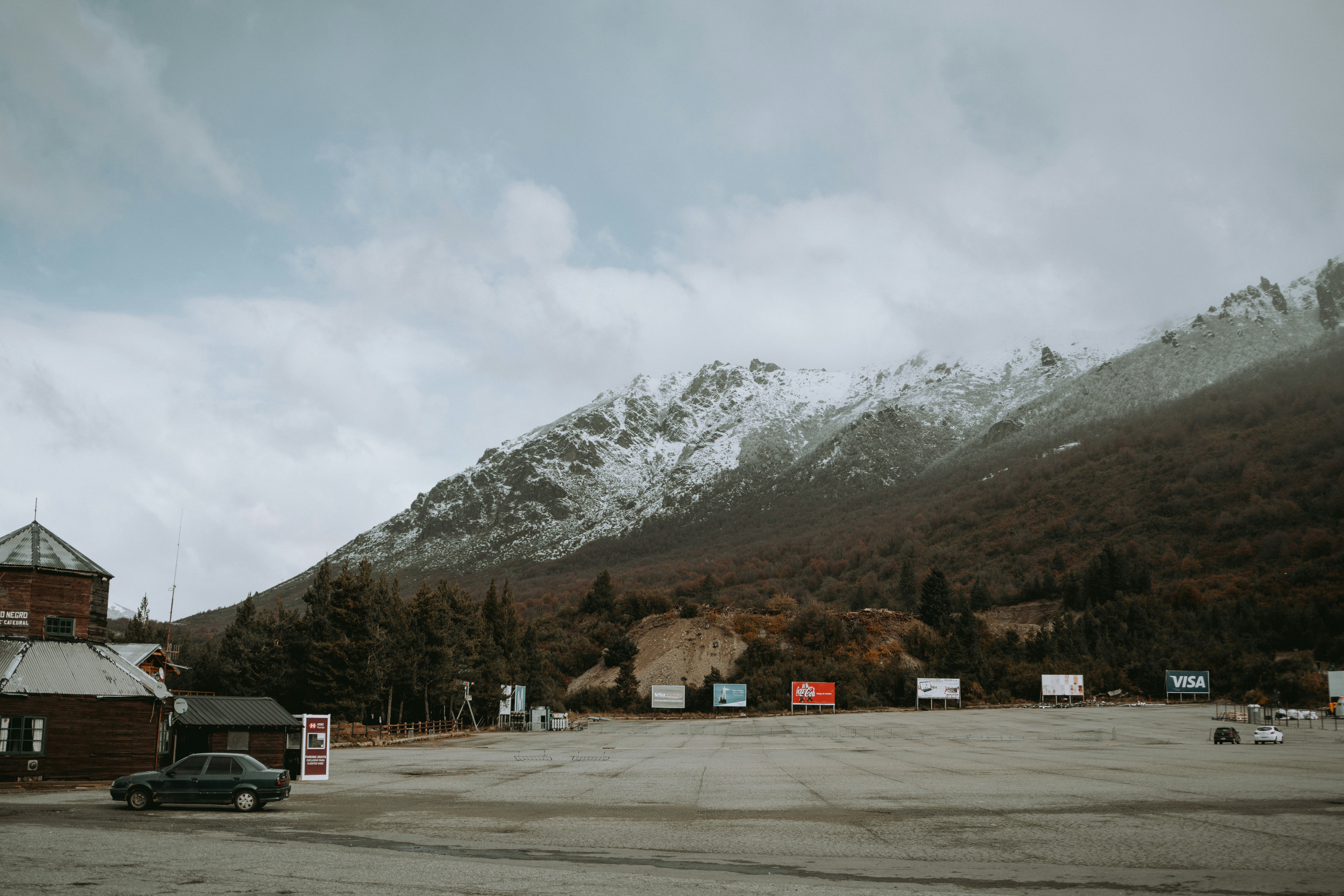 Snow-Kissed Ridge Over a Quiet Mountain Parking Lot