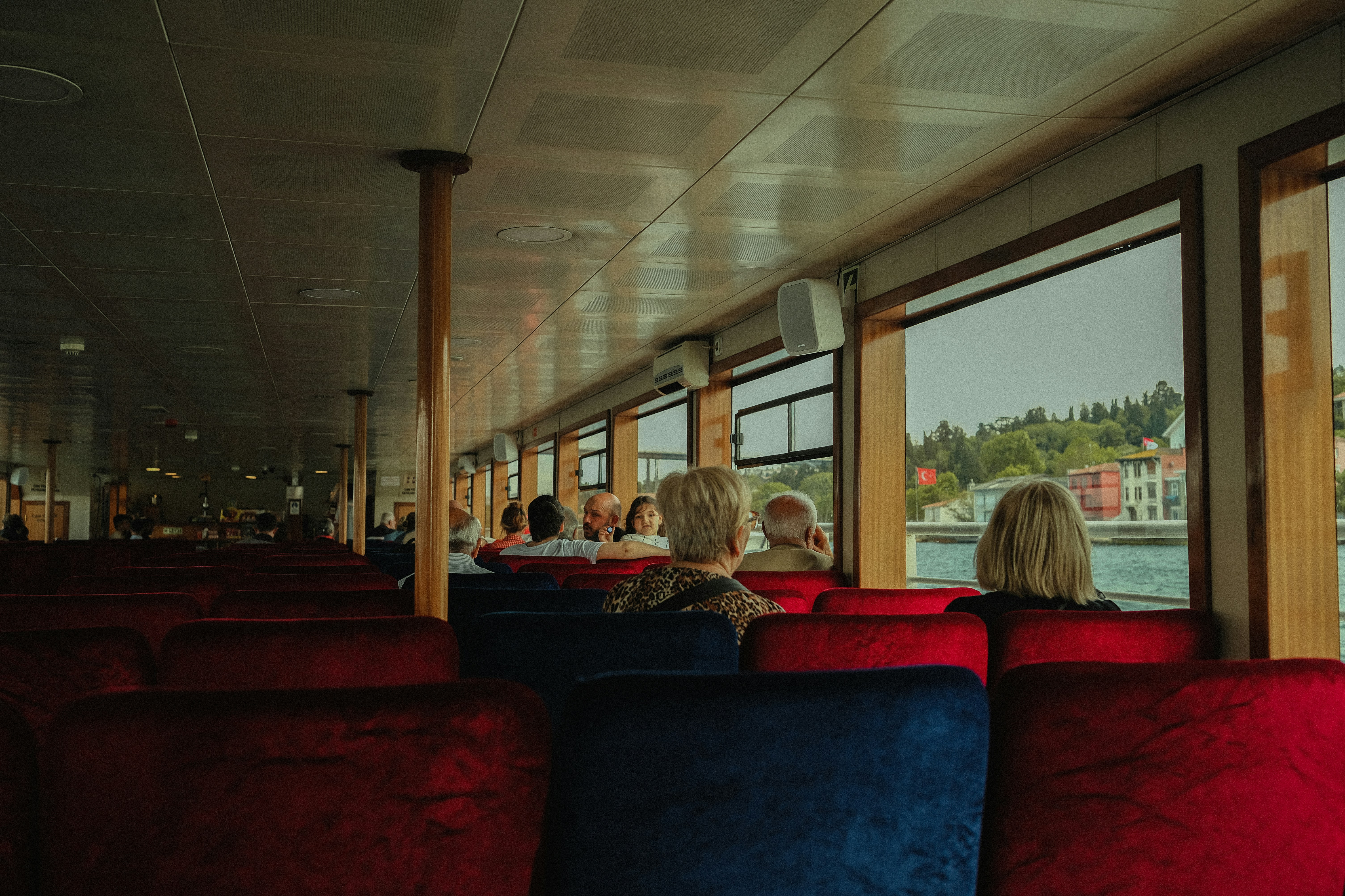 Quiet Deck: Passengers Gathered Amid Painted Velvet Seats