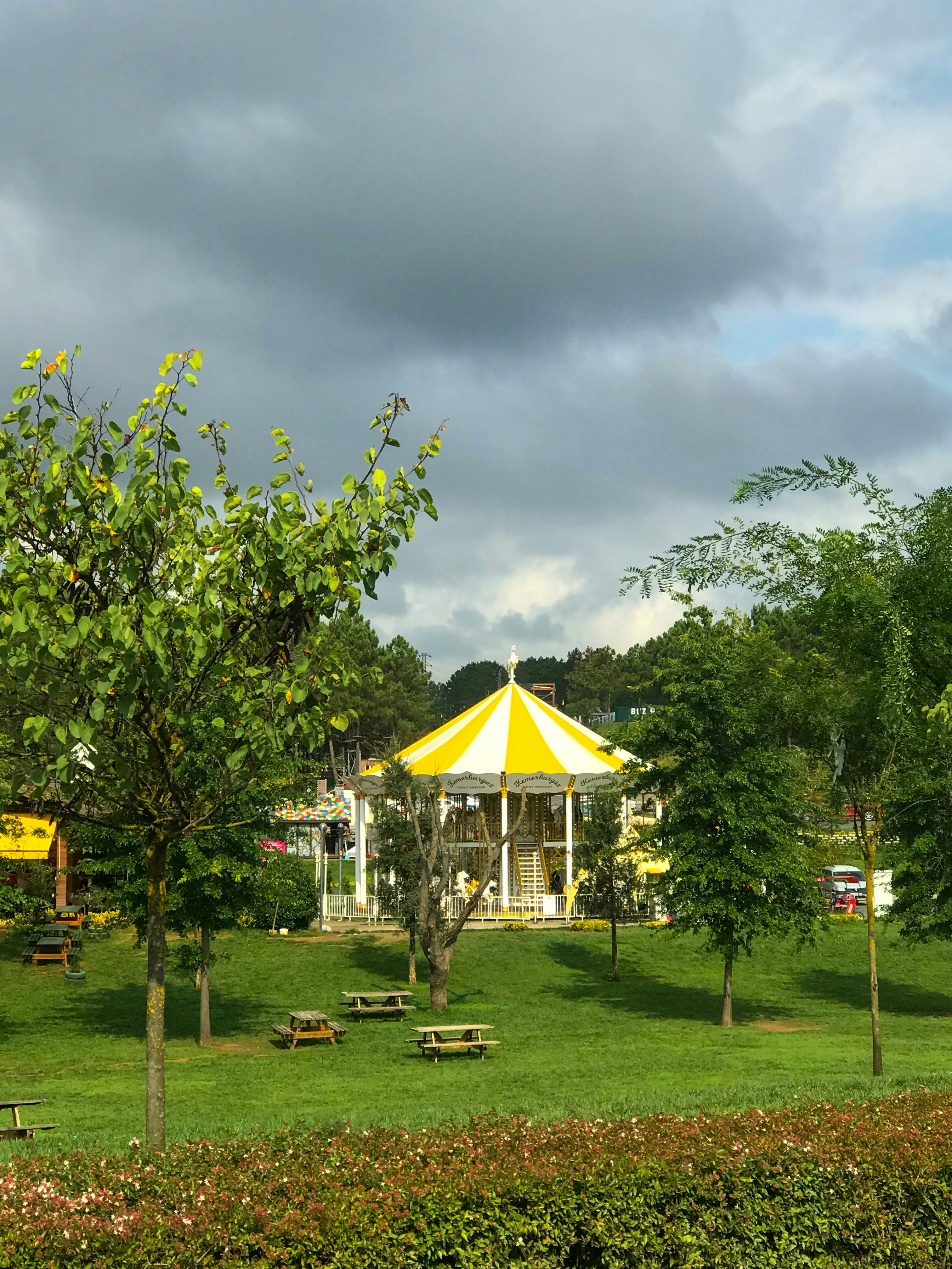 Yellow-and-White Pavilion Anchors a Quiet Park Under Cloudy Skies