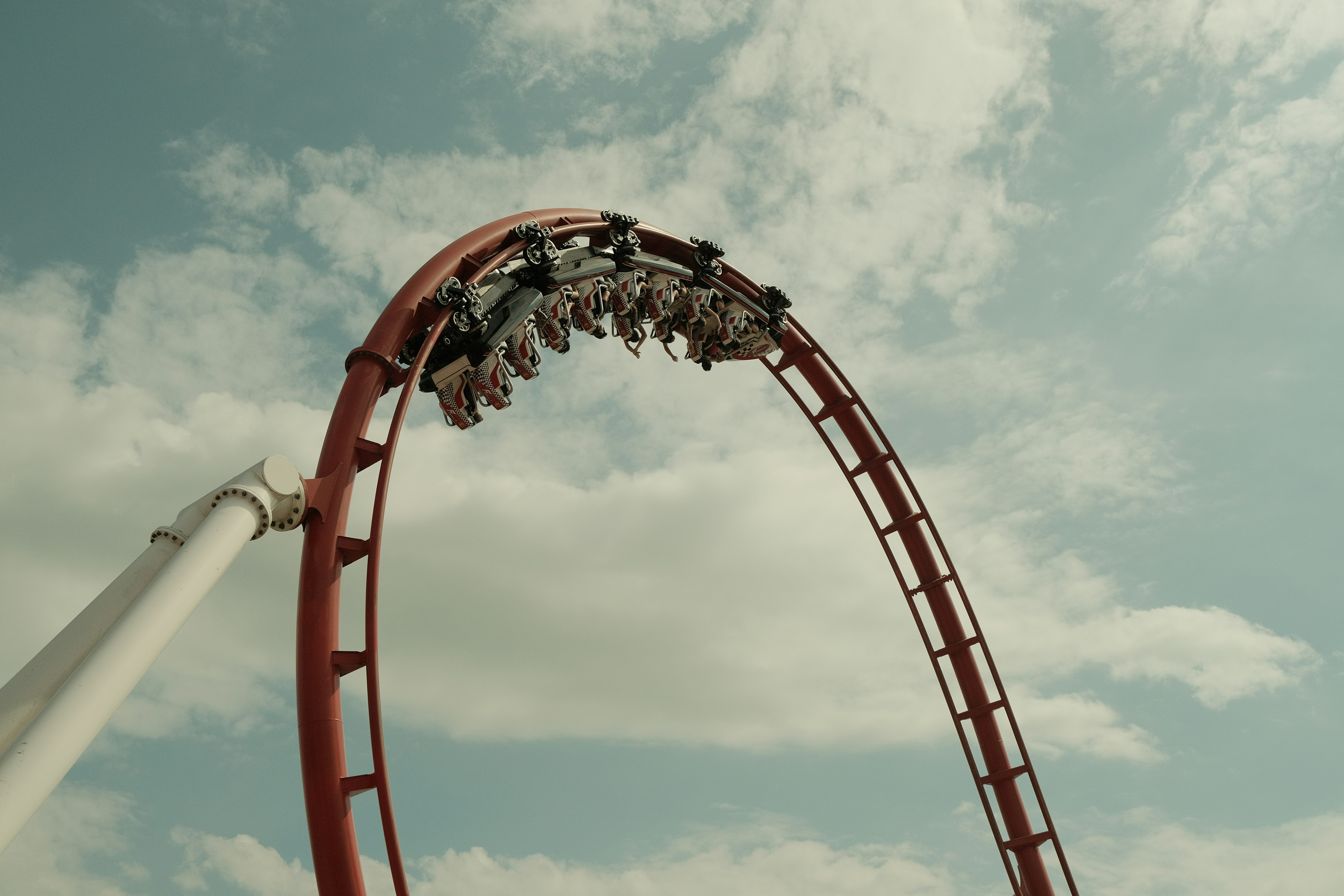 A roller coaster going through a cloudy sky photo – Free Roller coaster ...