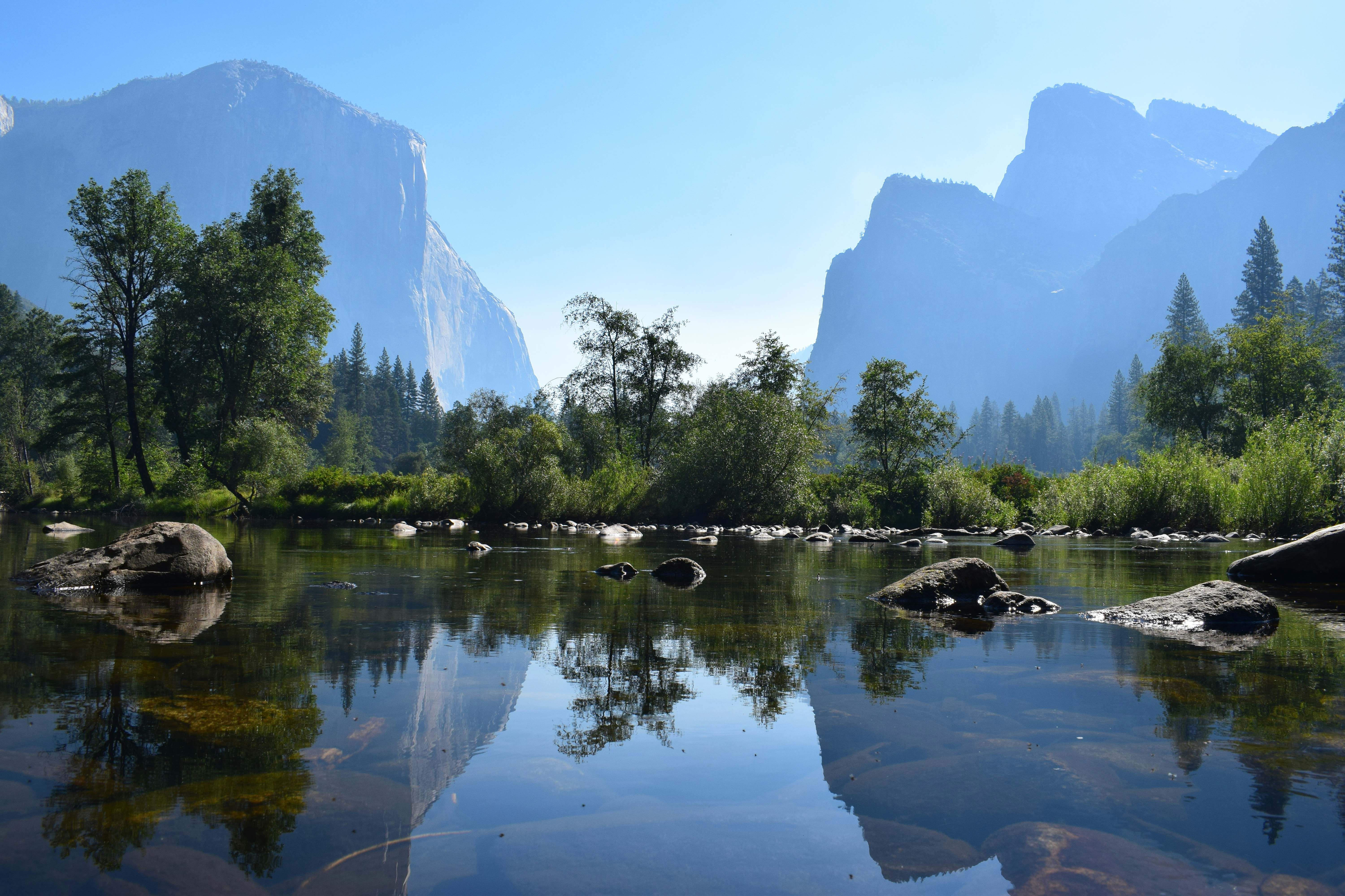 The Valleys Cliffs reflect in the water of Yosemite.