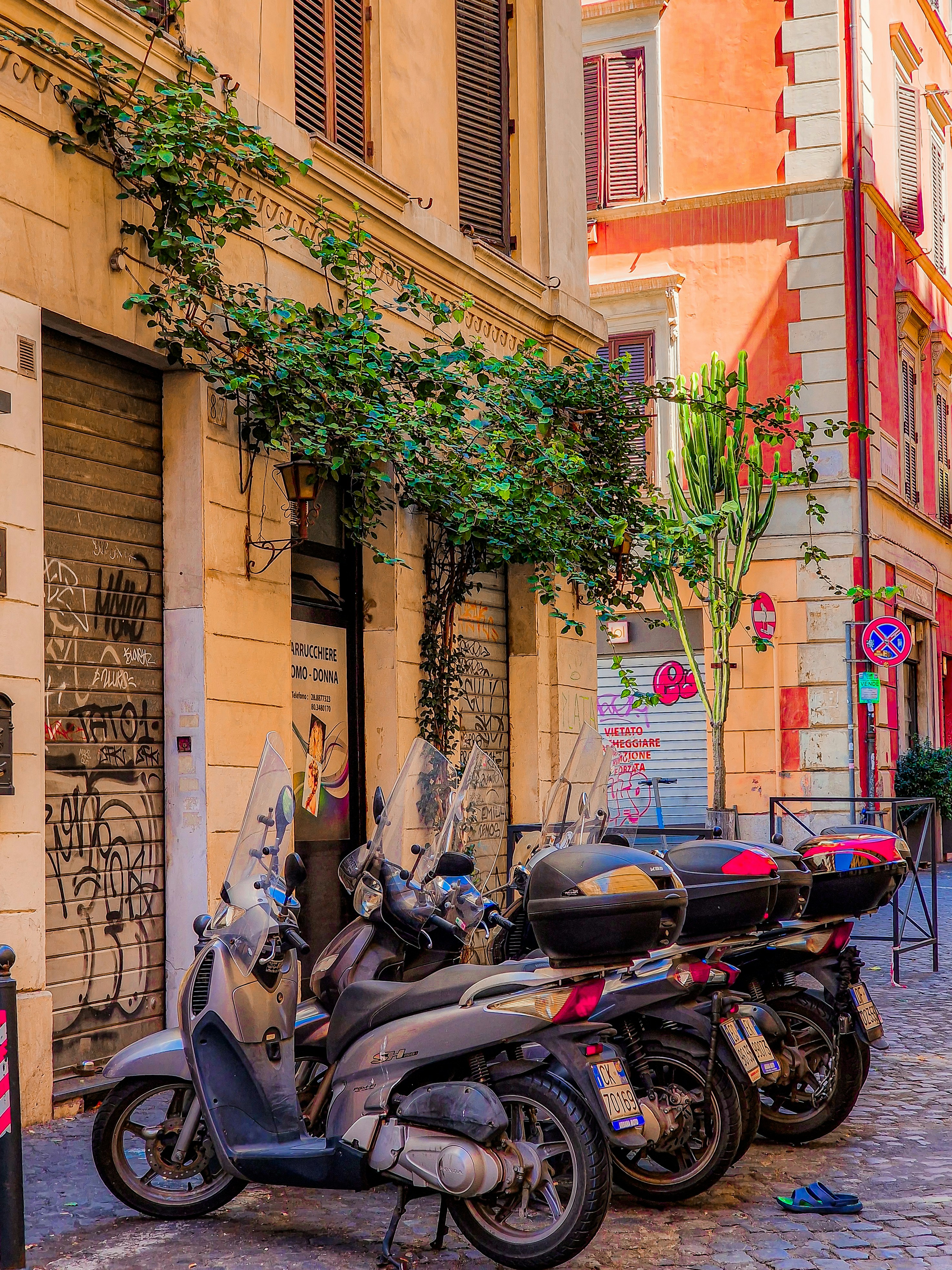 A row of motorcycles parked in front of a building photo – Free Rome ...