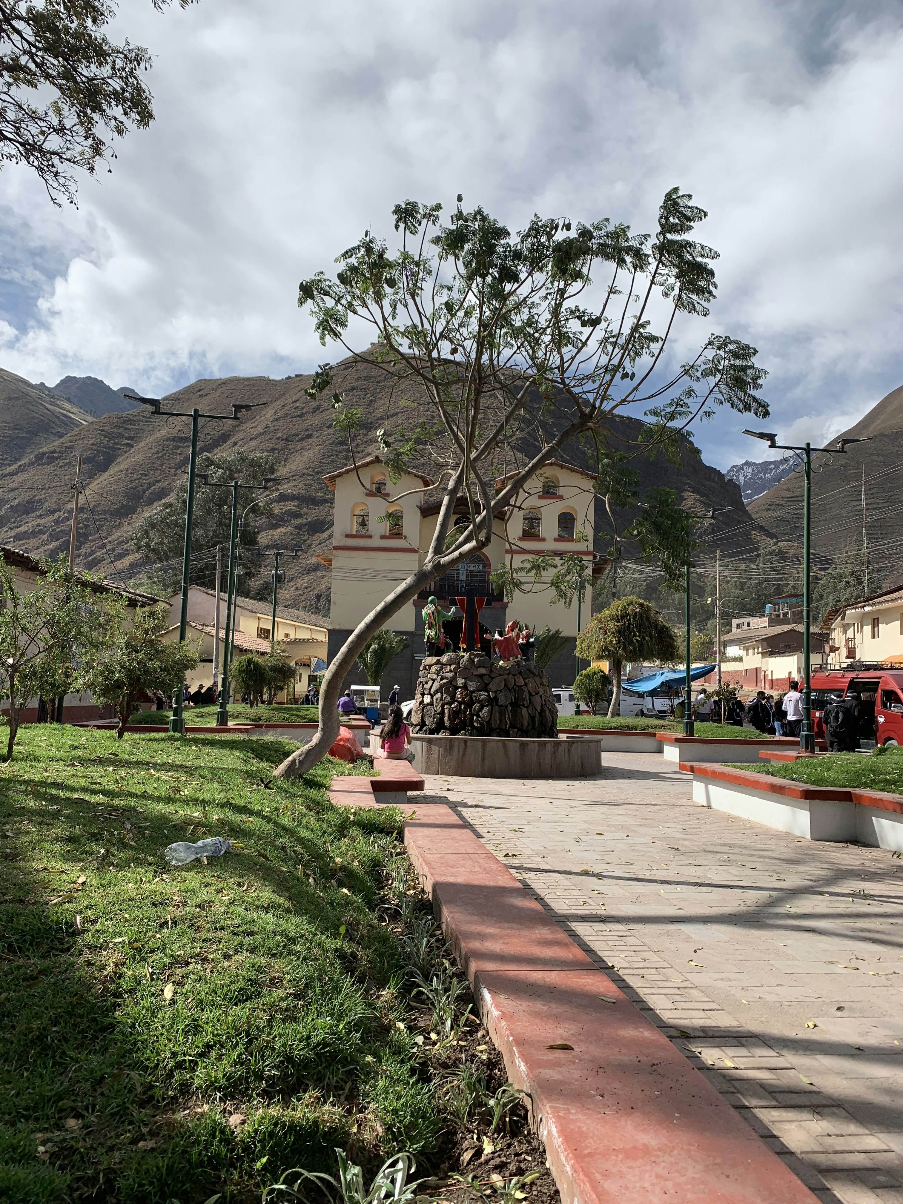Village Square with Focal Tree and Fountain under Mountain Backdrop