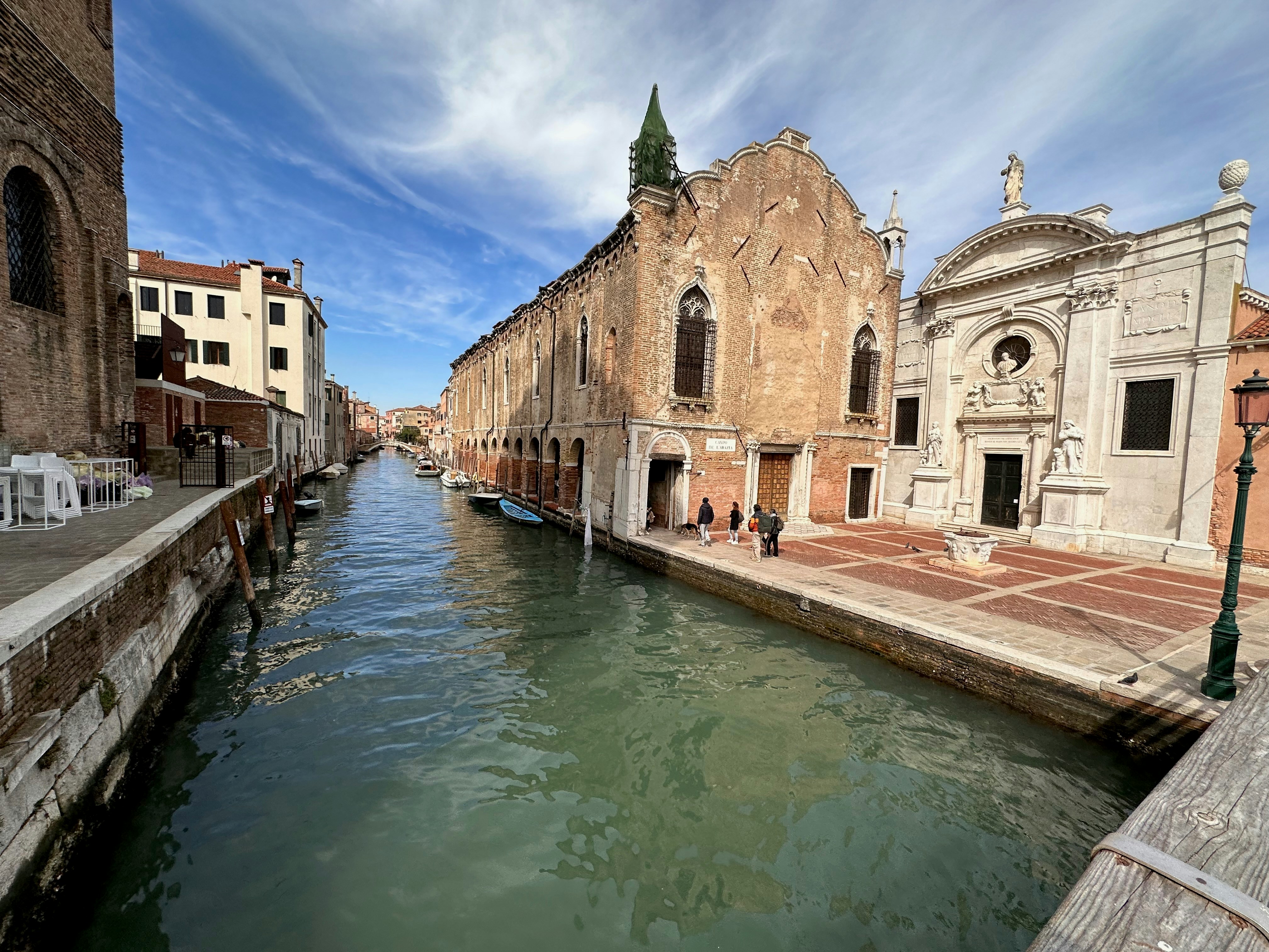 a narrow canal with a church in the background