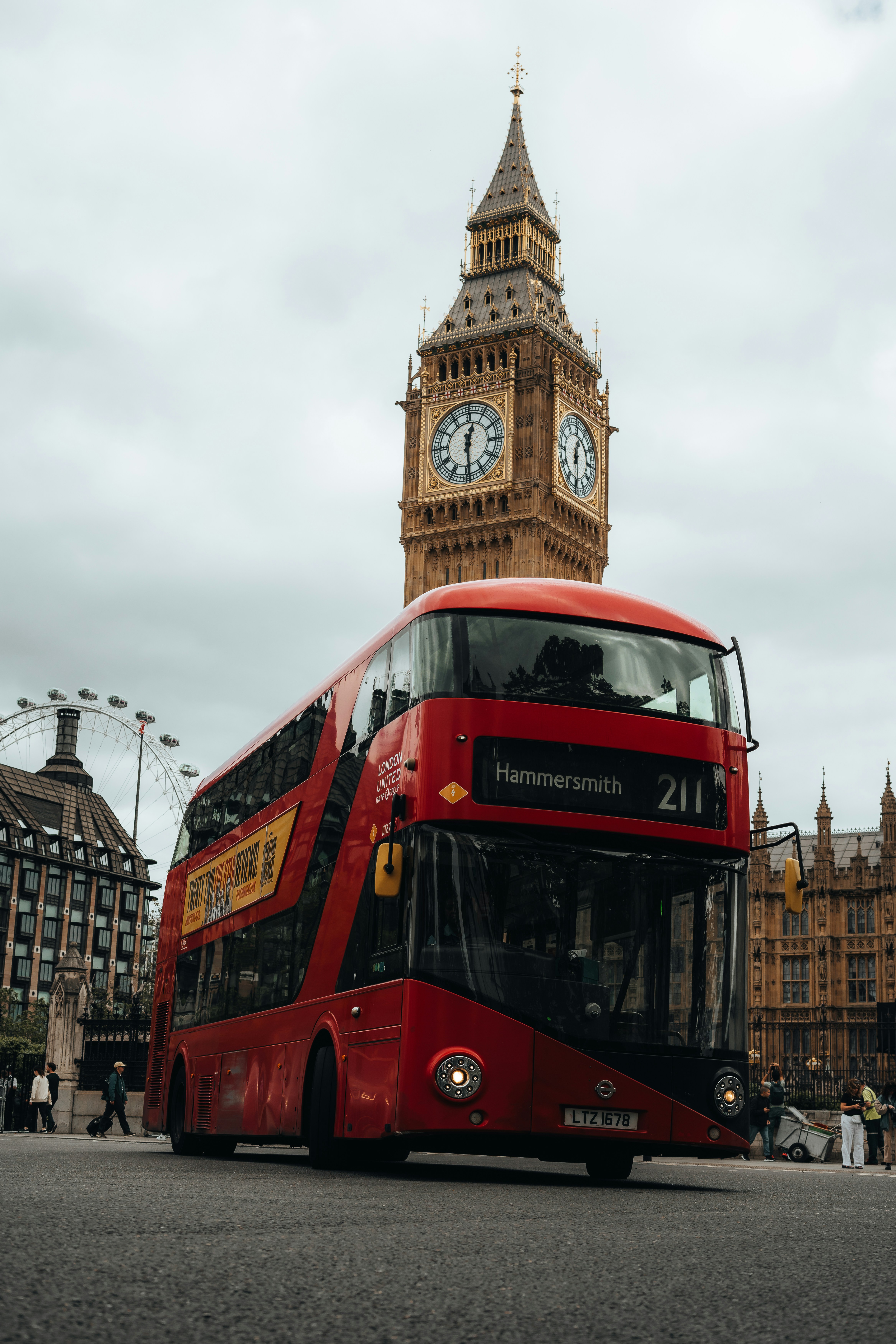 A red double decker bus driving past a clock tower photo – Free London ...