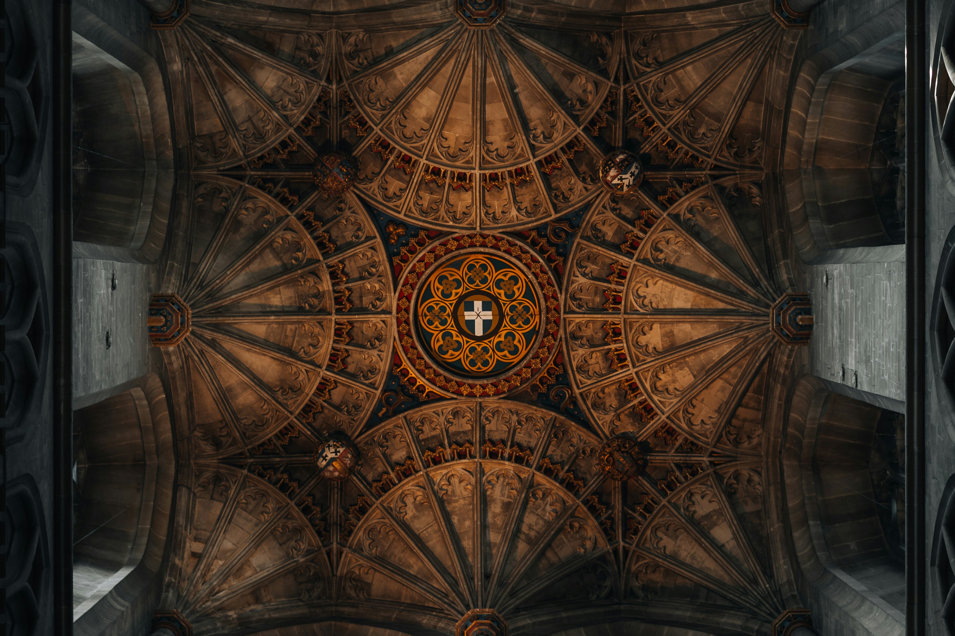 the ceiling of a cathedral with a cross in the center