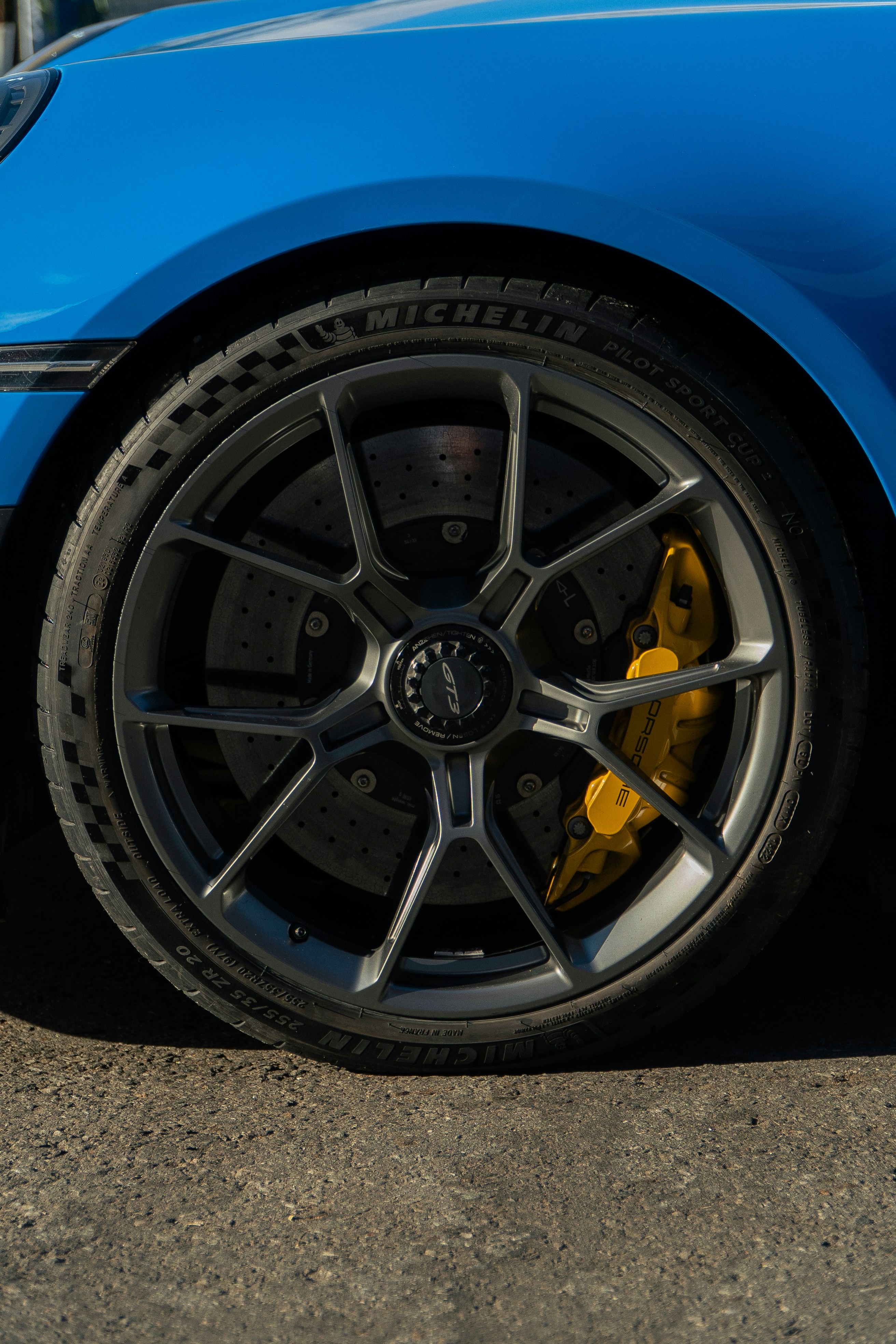 A blue sports car with yellow brake pads photo – Free Brazil Image on ...