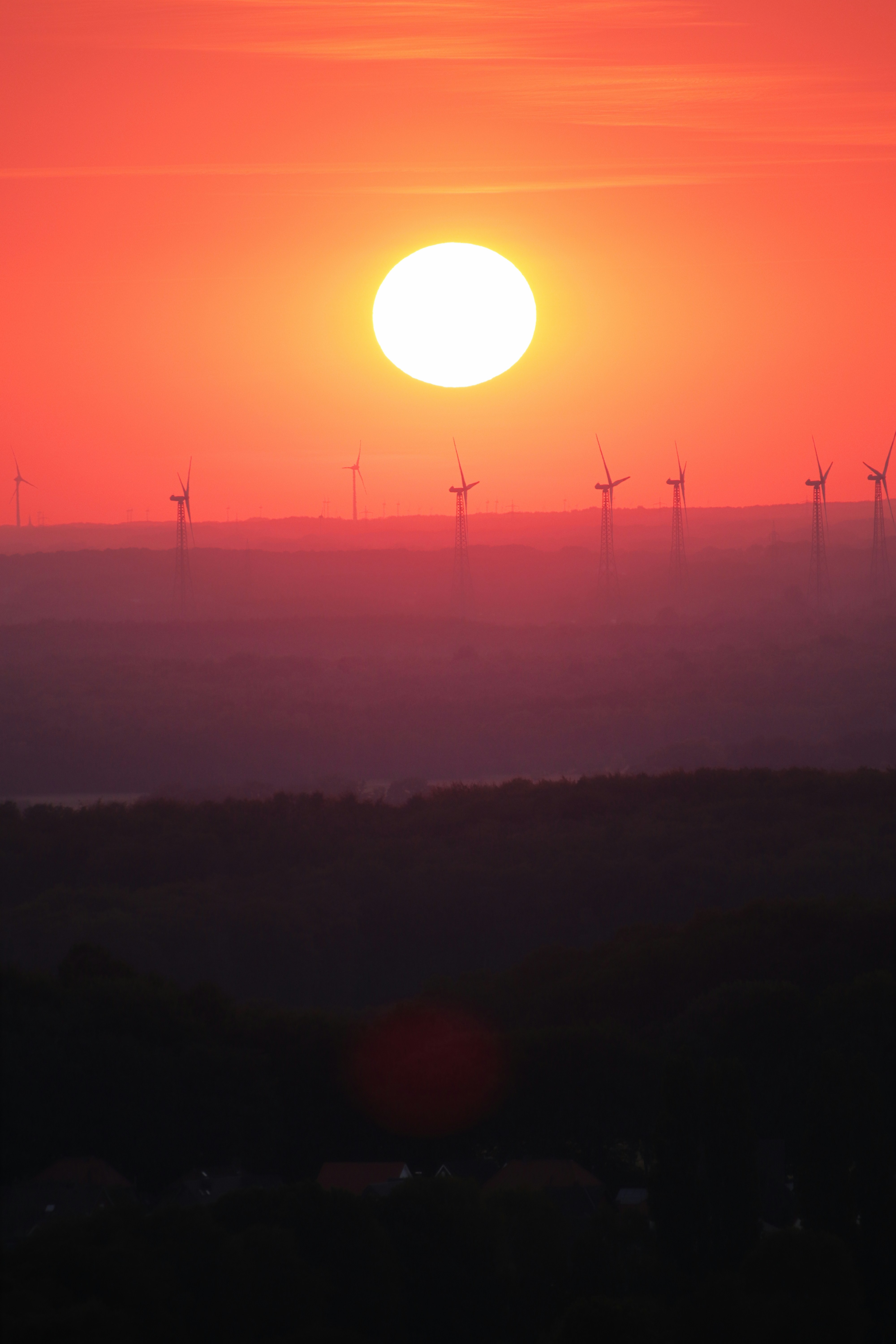 Crimson Horizon: Sunset Over a Quiet Wind Farm
