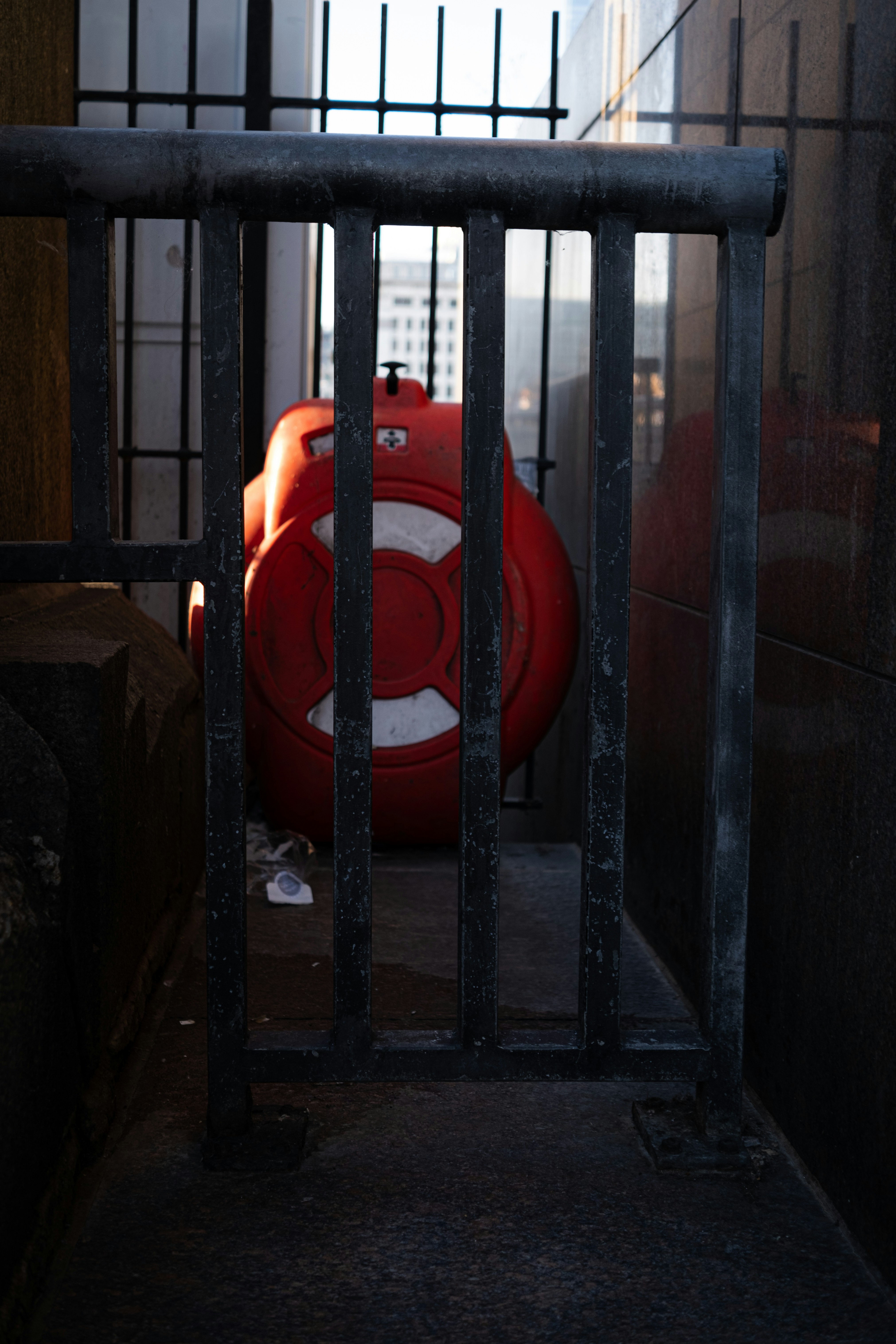 A red life preserver behind bars in a jail cell photo – Free Uk Image ...