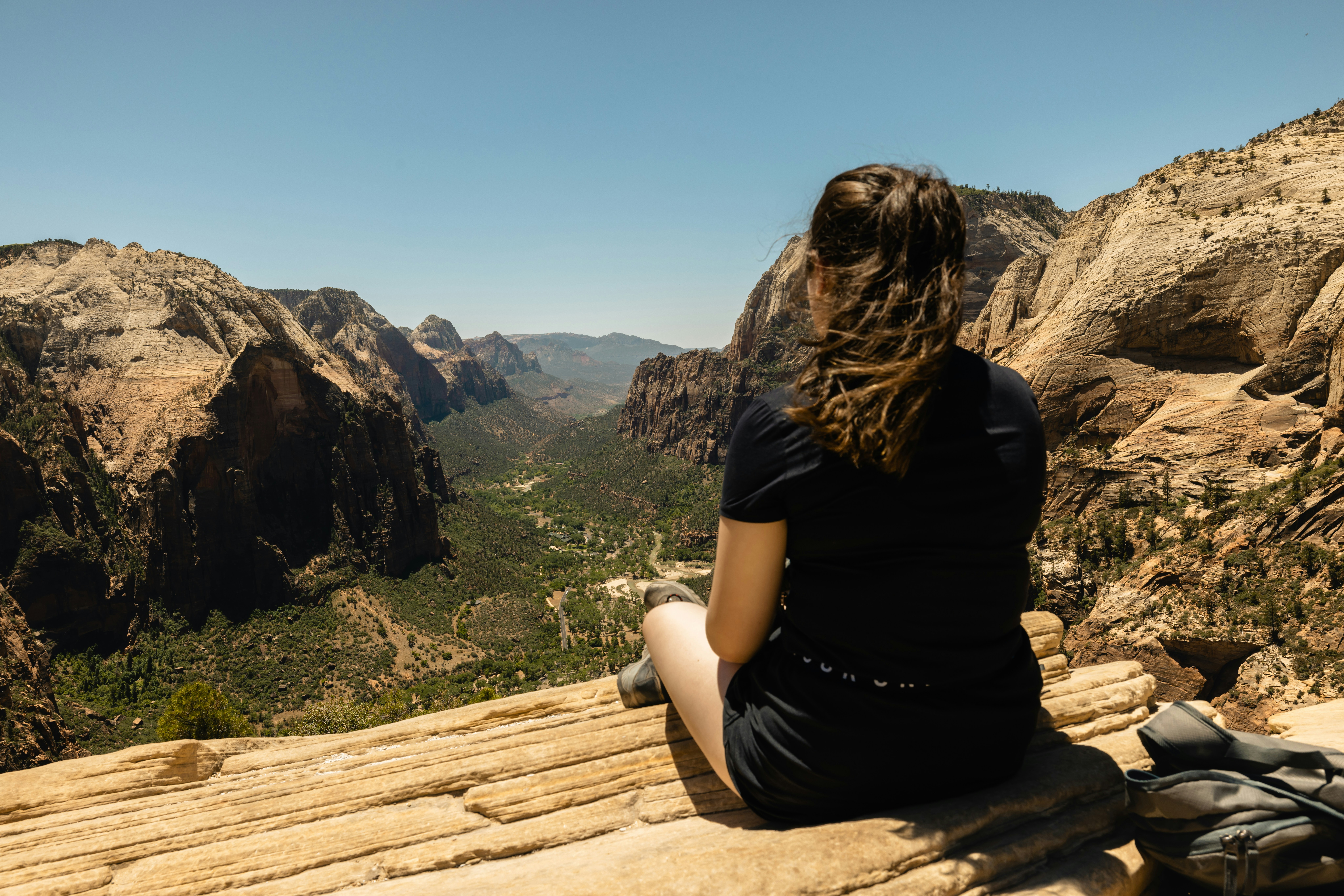 Woman overlooking Valley from Angels Landing at Zion National Park.