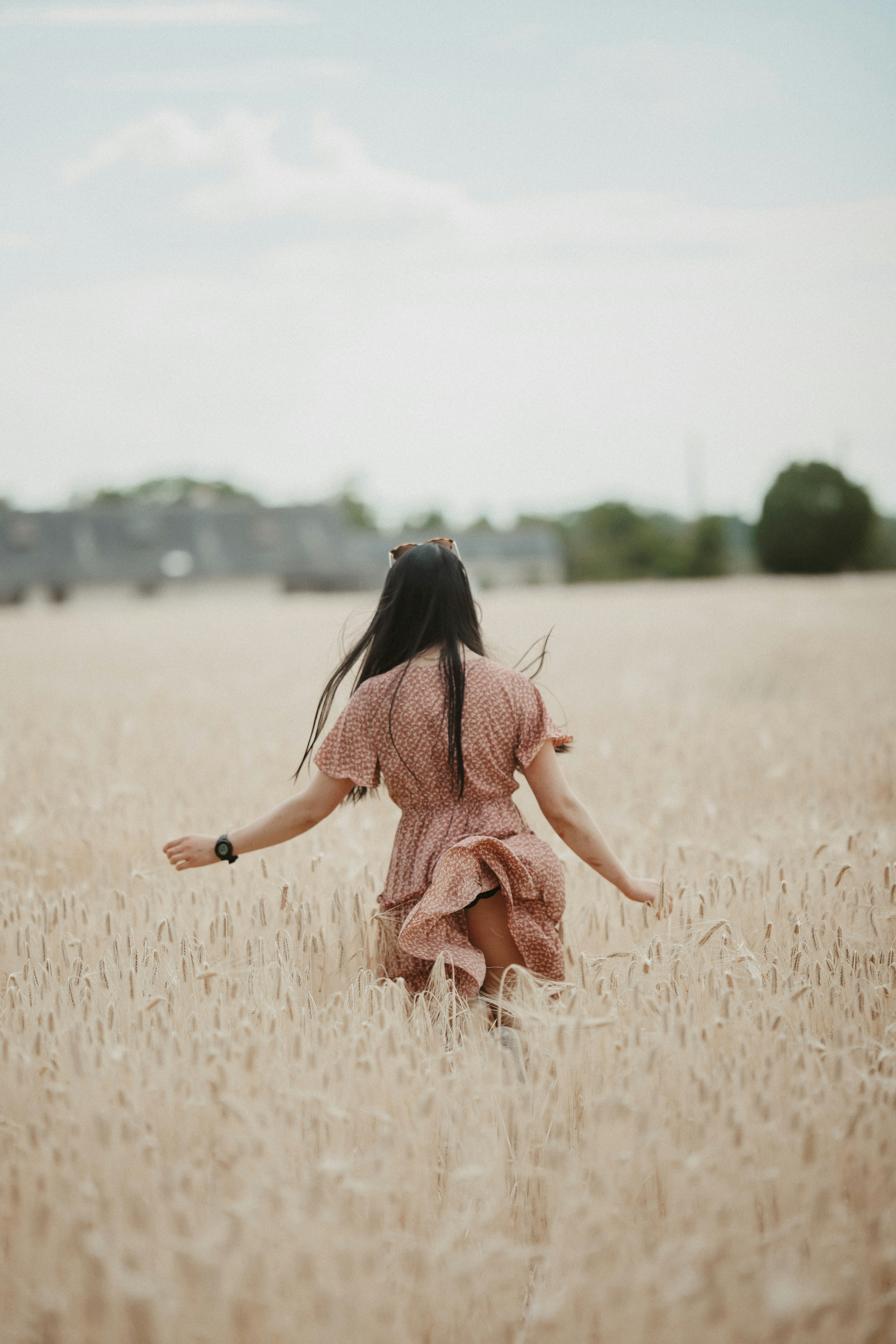 A young girl running through a field of wheat photo – Free Girl Image ...
