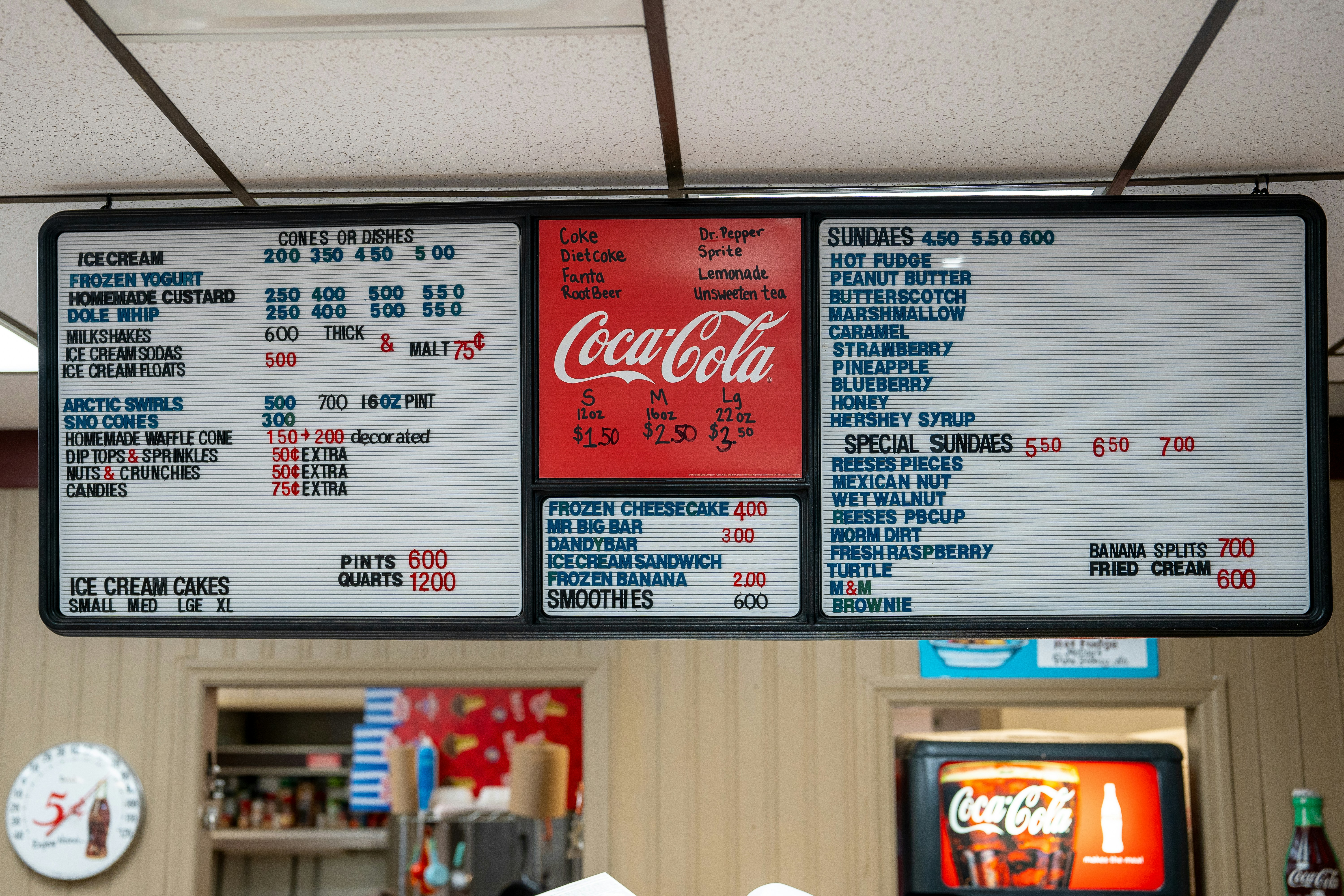 A menu for a fast food restaurant hanging from a ceiling photo – Free ...