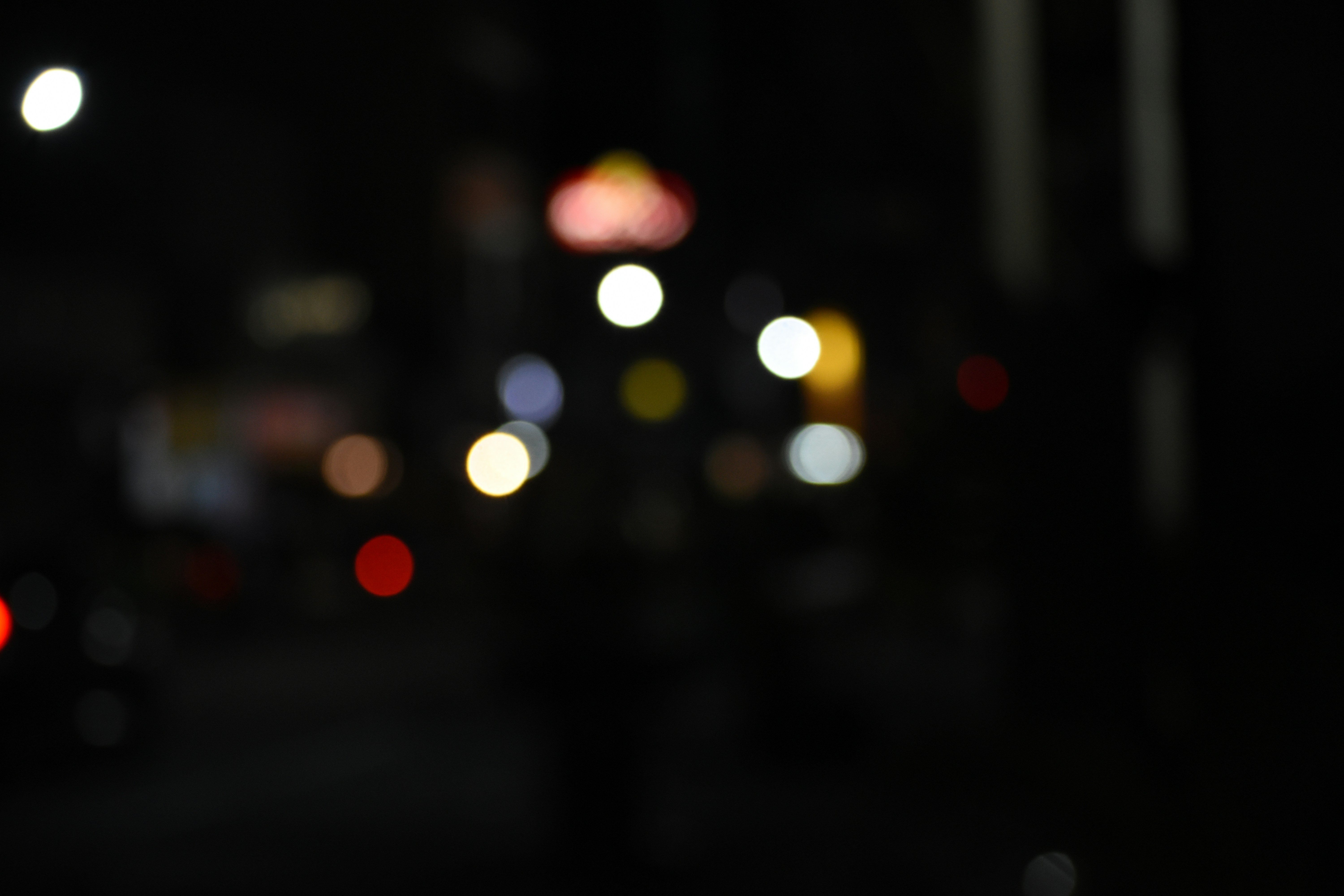 blurry street lights background | a blurry photo of a city street at night