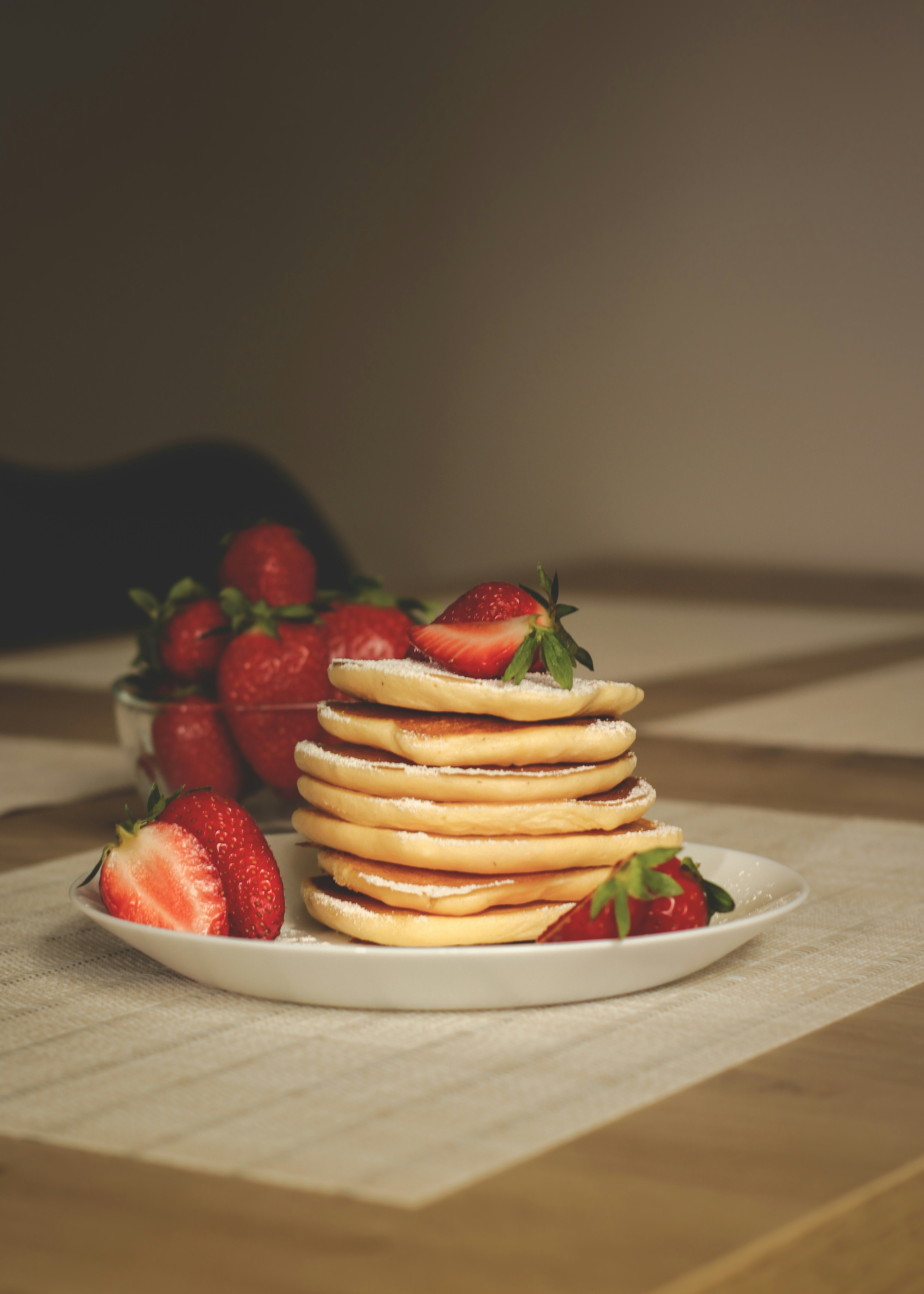 A stack of pancakes with strawberries on a plate photo – Free Food ...