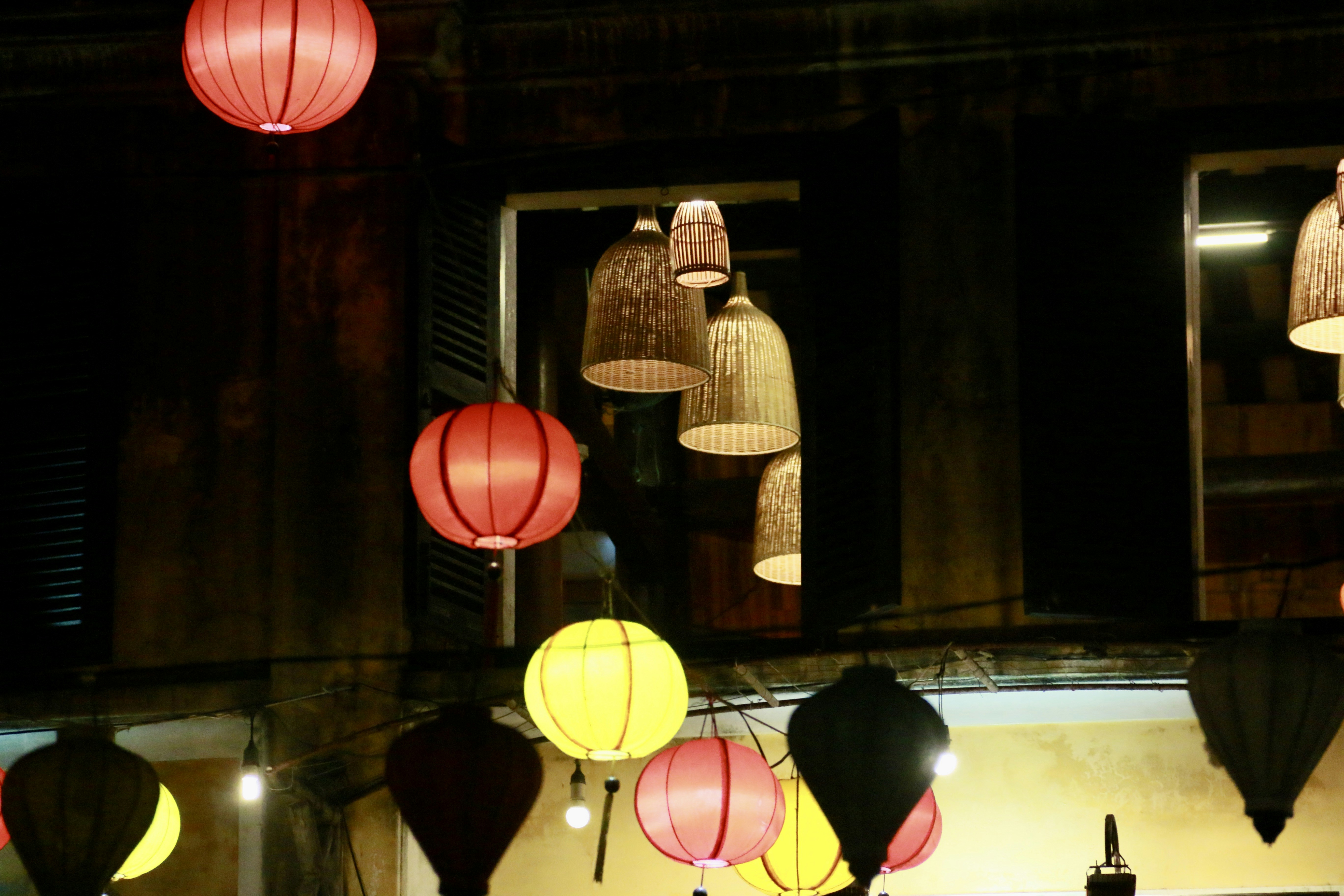 Orbs of Warm Color Hover Over a Quiet Night Facade